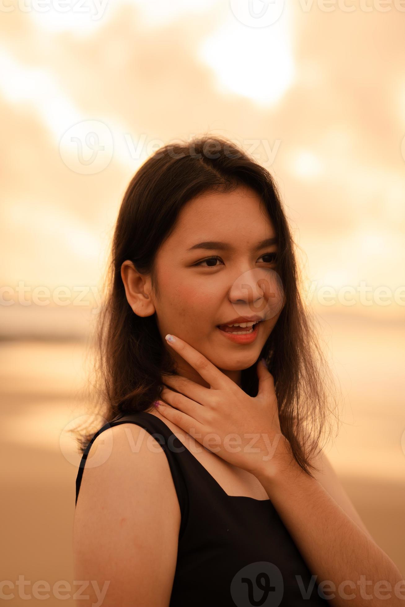 An Asian Teenage Woman With A Black Shirt And Black Hair Has A Cute