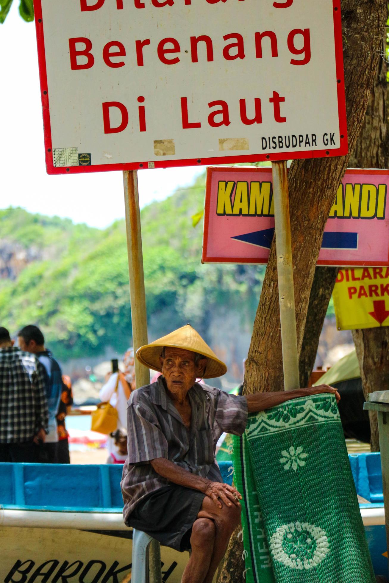 Yogyakarta, Indonesia in November 2022. Photo of a grandfather or old man renting mats at Baron ...