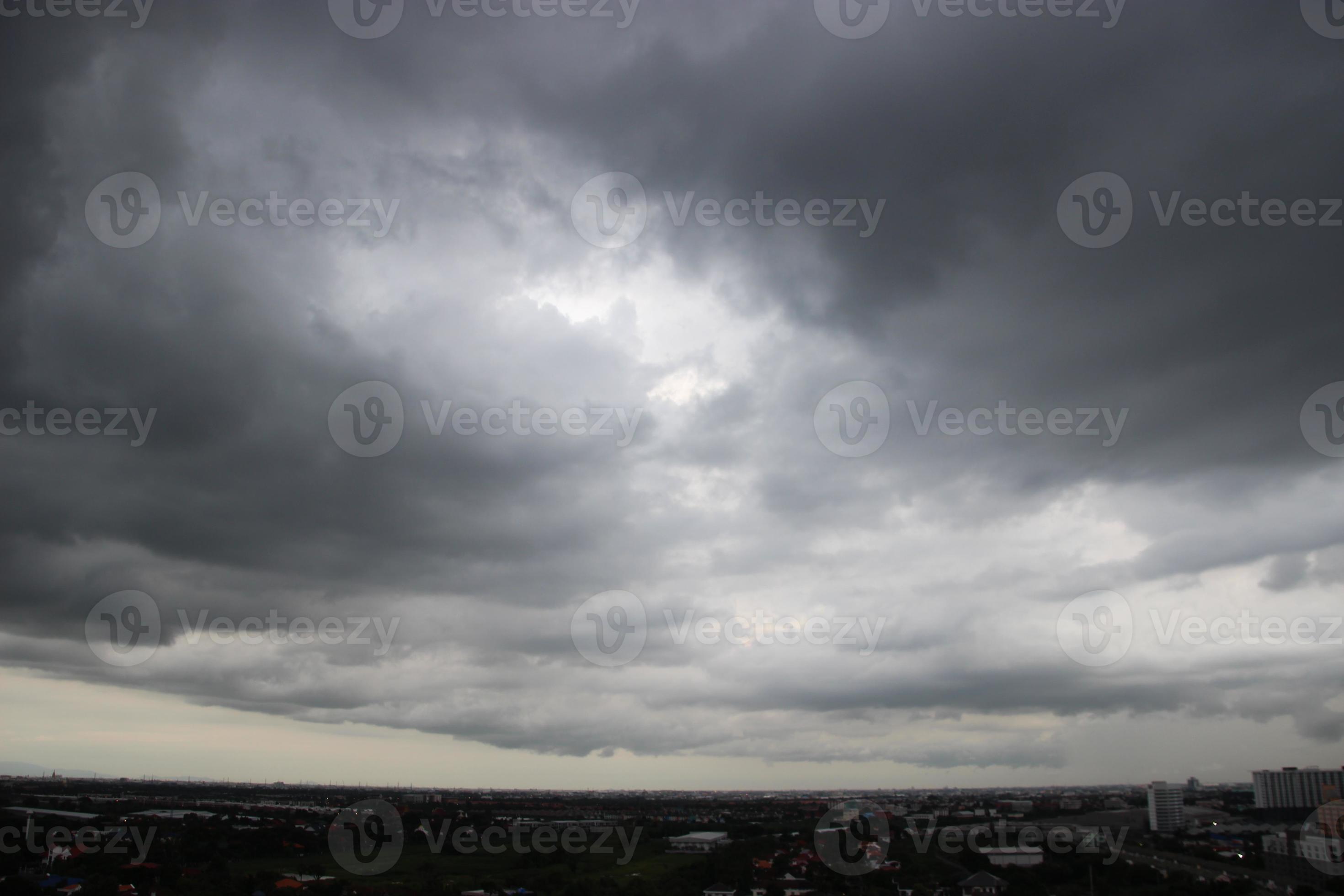 sunset sky above heavy dark clouds almost raining with dramatic Rays of light shining down ...
