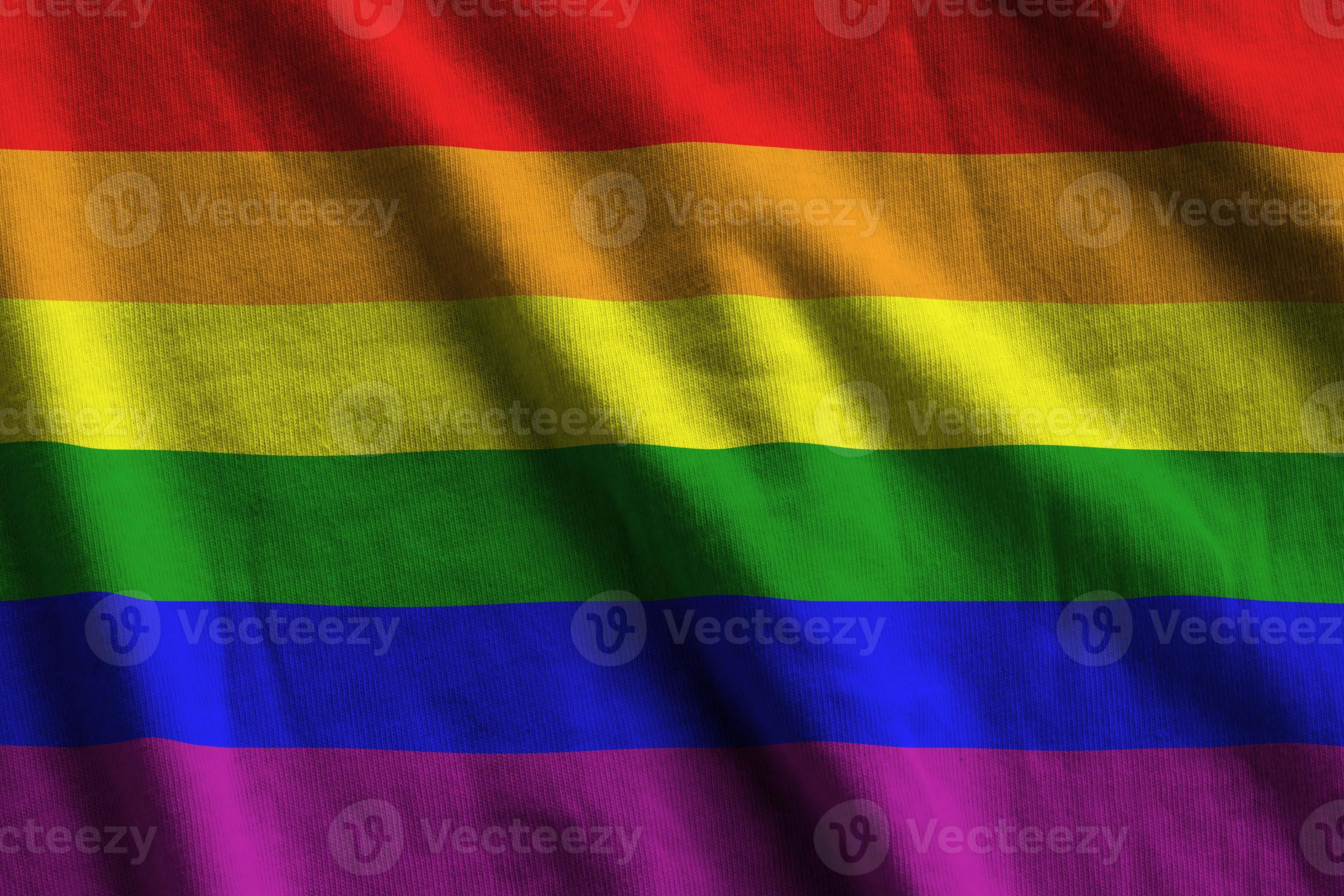LGBT community flag with big folds waving close up under the studio ...