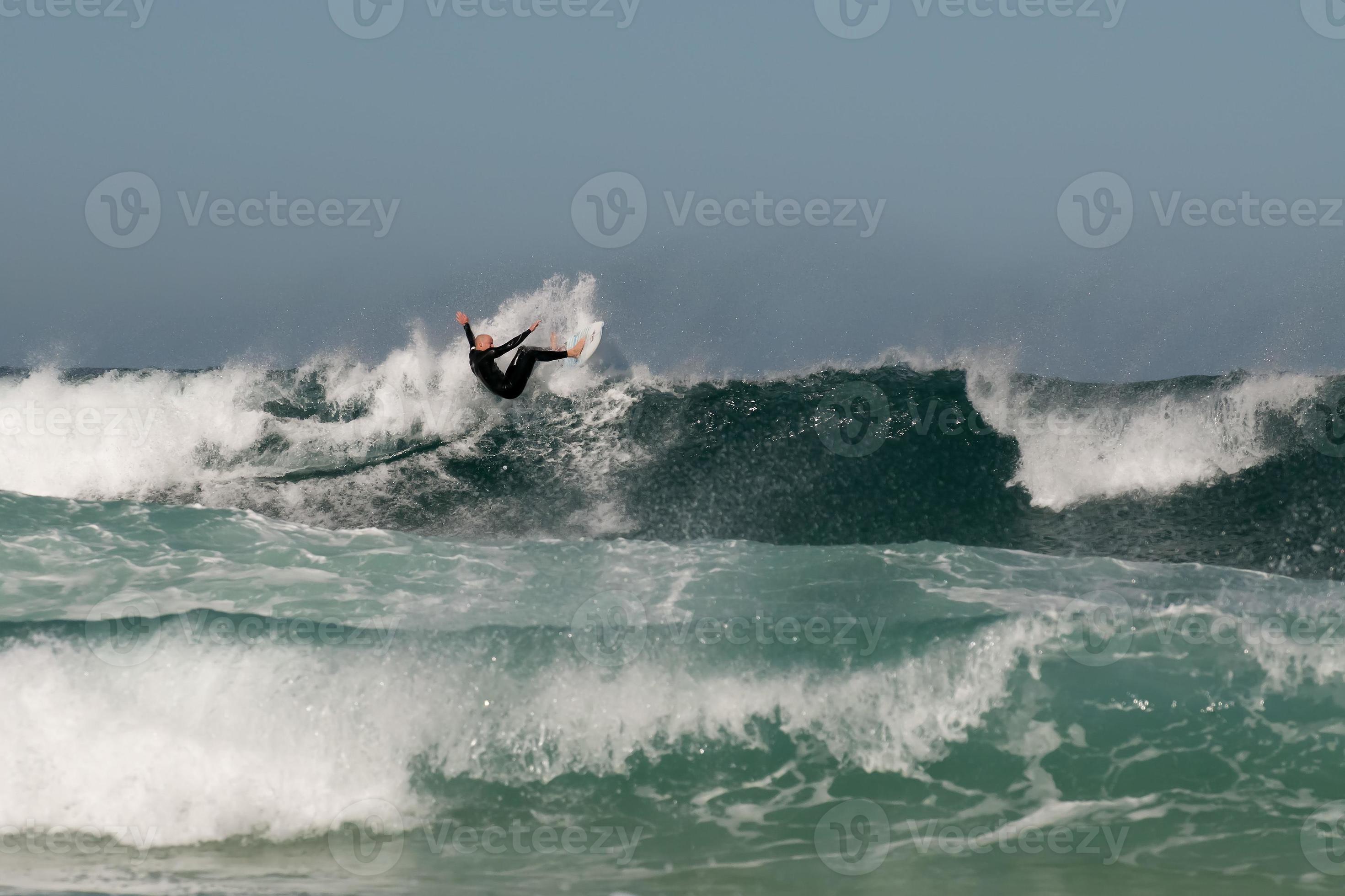 An isolated surfer jumping on big waves 20225333 Stock Photo at Vecteezy