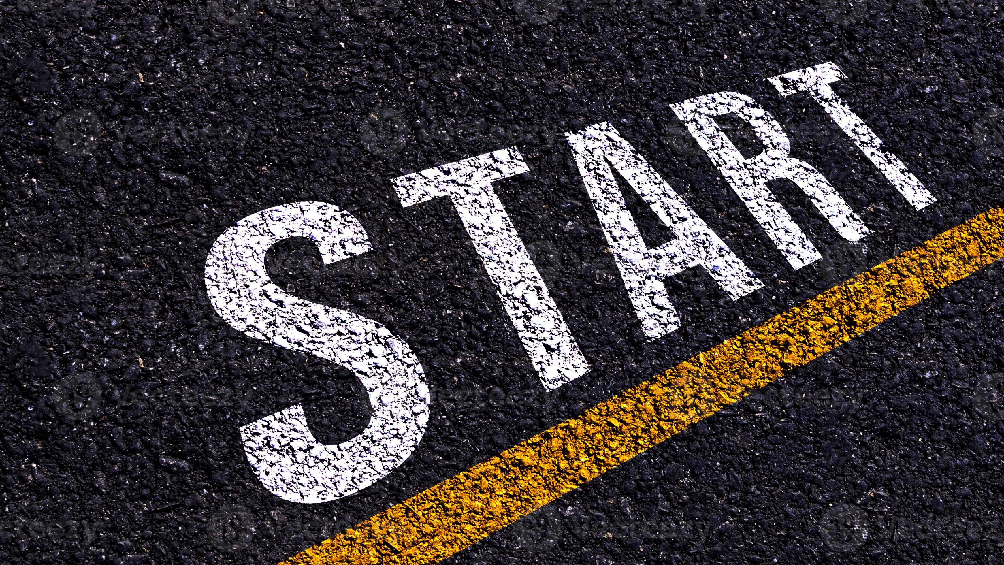 Start text written and line on the road in middle of the asphalt road ...