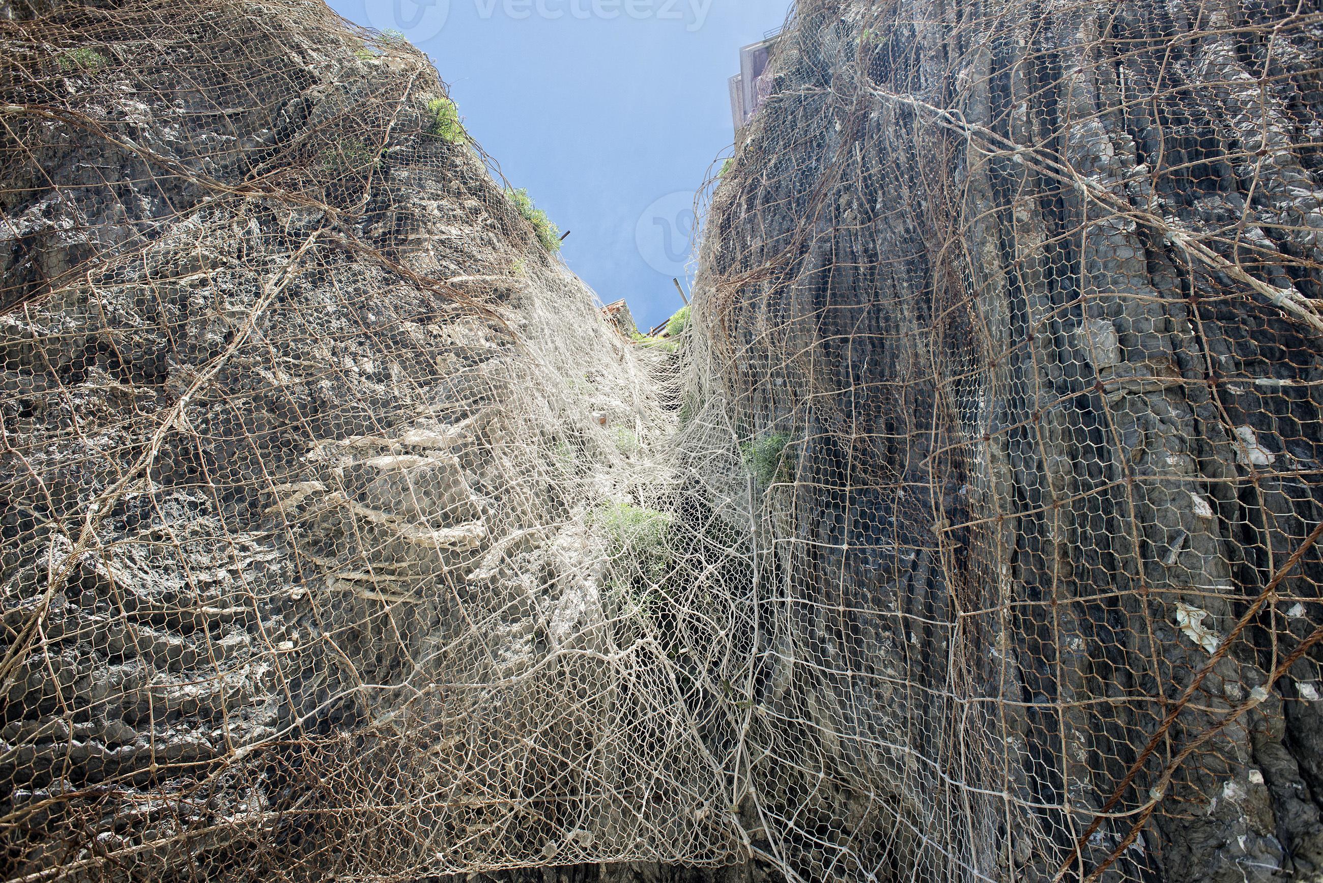 Metallic grid on rocks to prevent collapse in Cinque terre village ... Metallic grid on rocks to prevent collapse in Cinque terre village ...