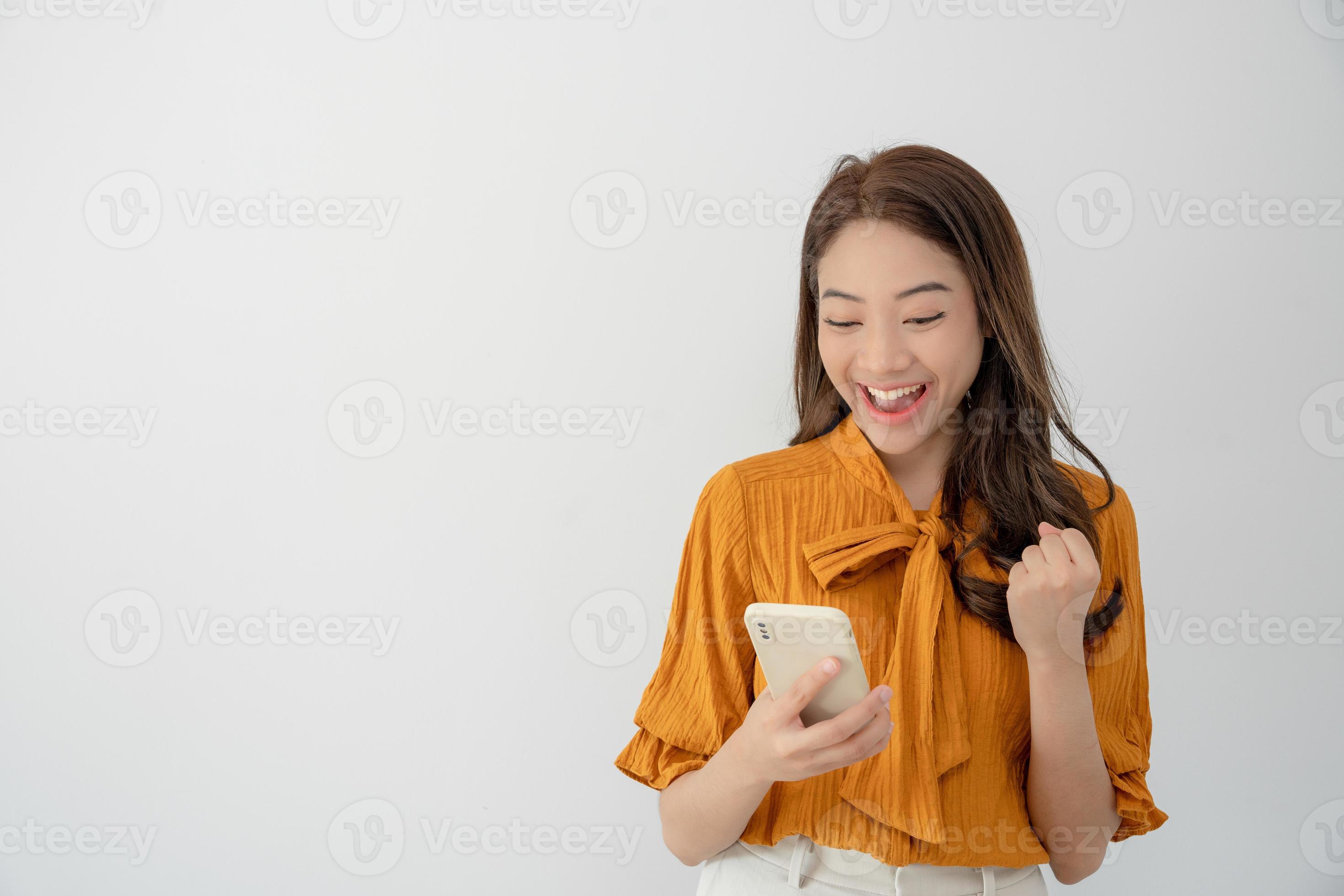 Asian beautiful woman exited surprise face expression . female feels shocked with the phone ...