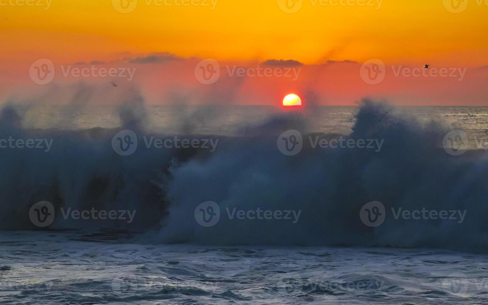 Colorful golden sunset big wave and beach Puerto Escondido Mexico ...