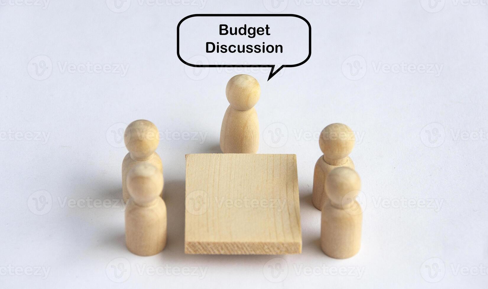 Wooden people figures having budget discussion meeting. Budgeting ... Wooden people figures having budget discussion meeting. Budgeting ...