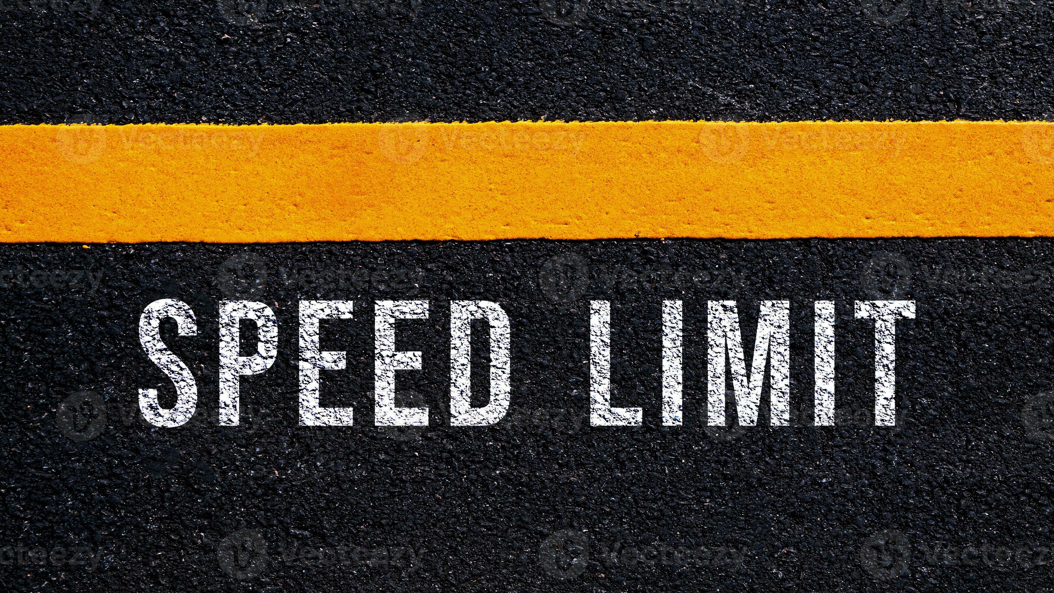 Speed Limit written and yellow line on the road in middle of the asphalt road, Speed Limit word ...