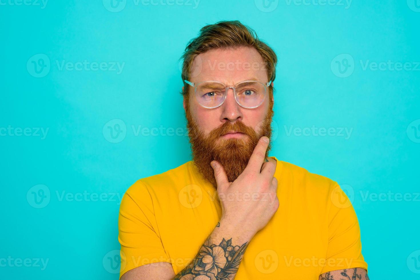Man With Yellow T Shirt And Beard Is Very Undecided 20688855 Stock