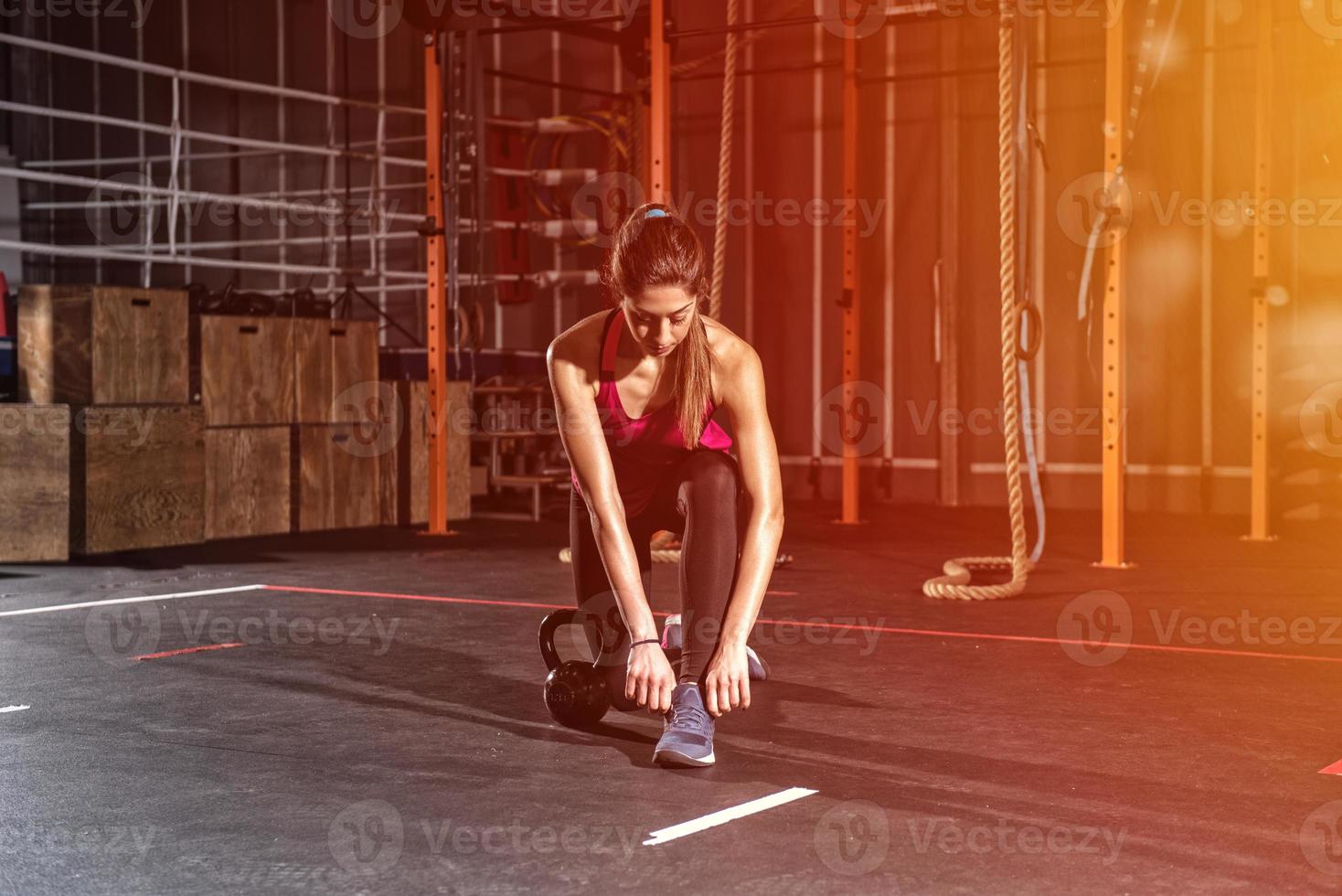 Athletic girl ready to start exercises with a kettlebell at the gym 20723398 Stock Photo at Vecteezy