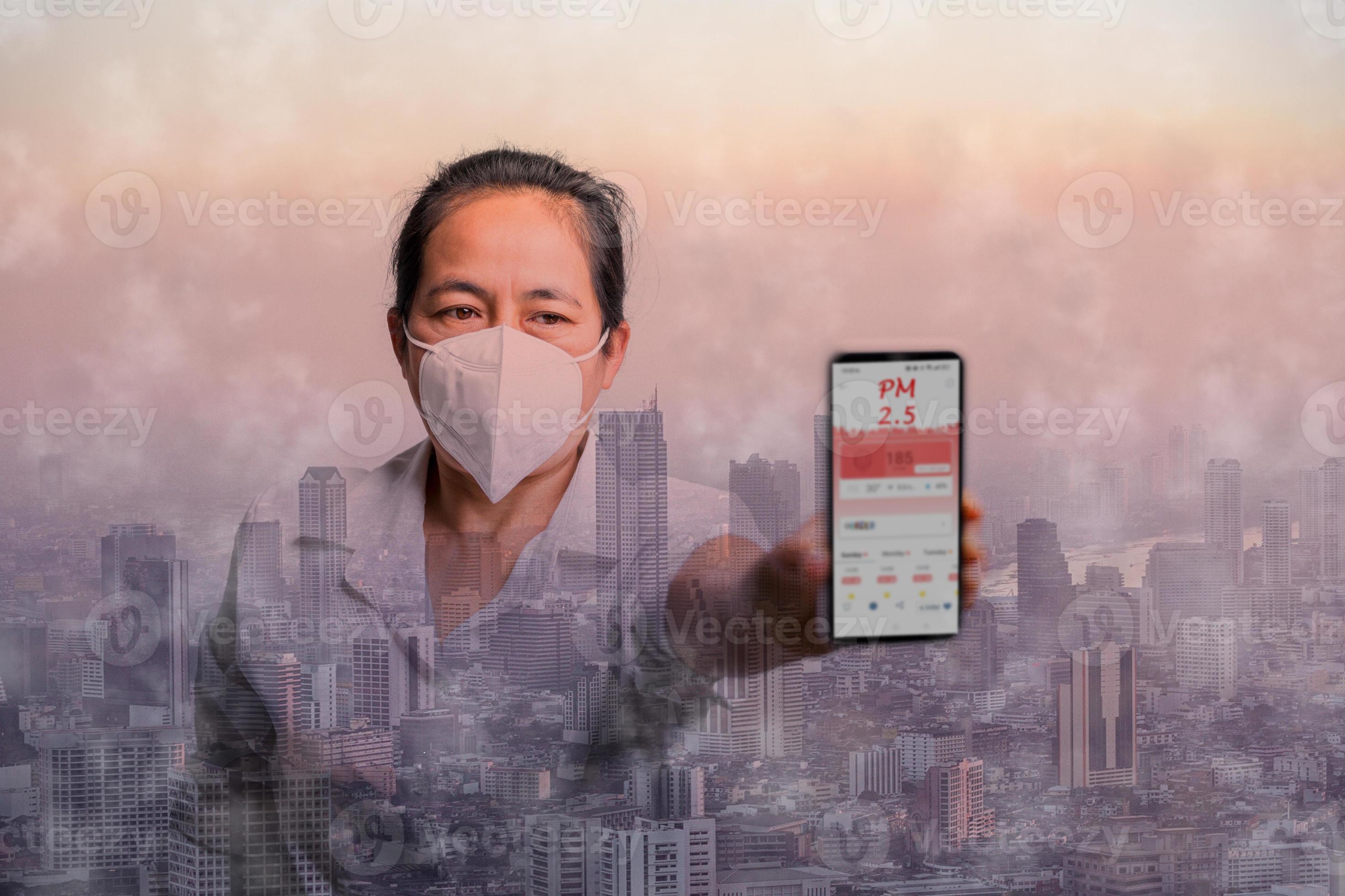 Woman wearing N95 PM 2.5 respiratory protection mask against air pollution and dust particles ...