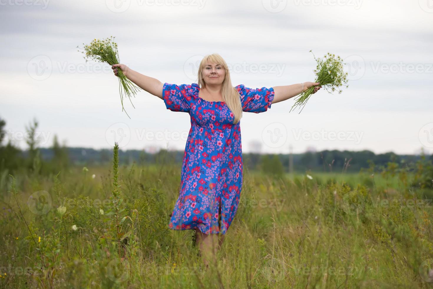 Beautiful plus size woman with white hair in a summer dress posing ...