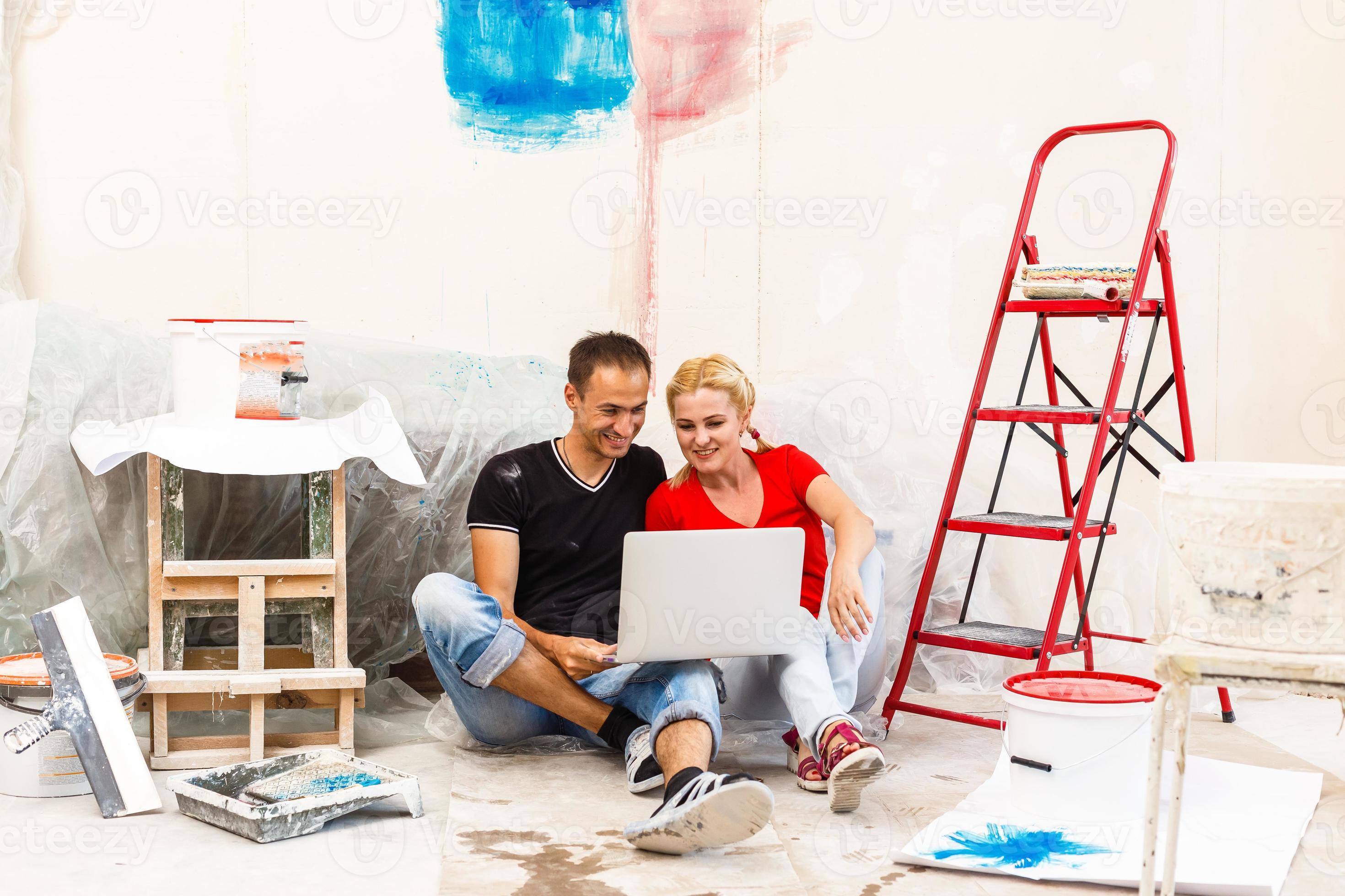 Young people select color for coloring of walls in the room. The guy ...