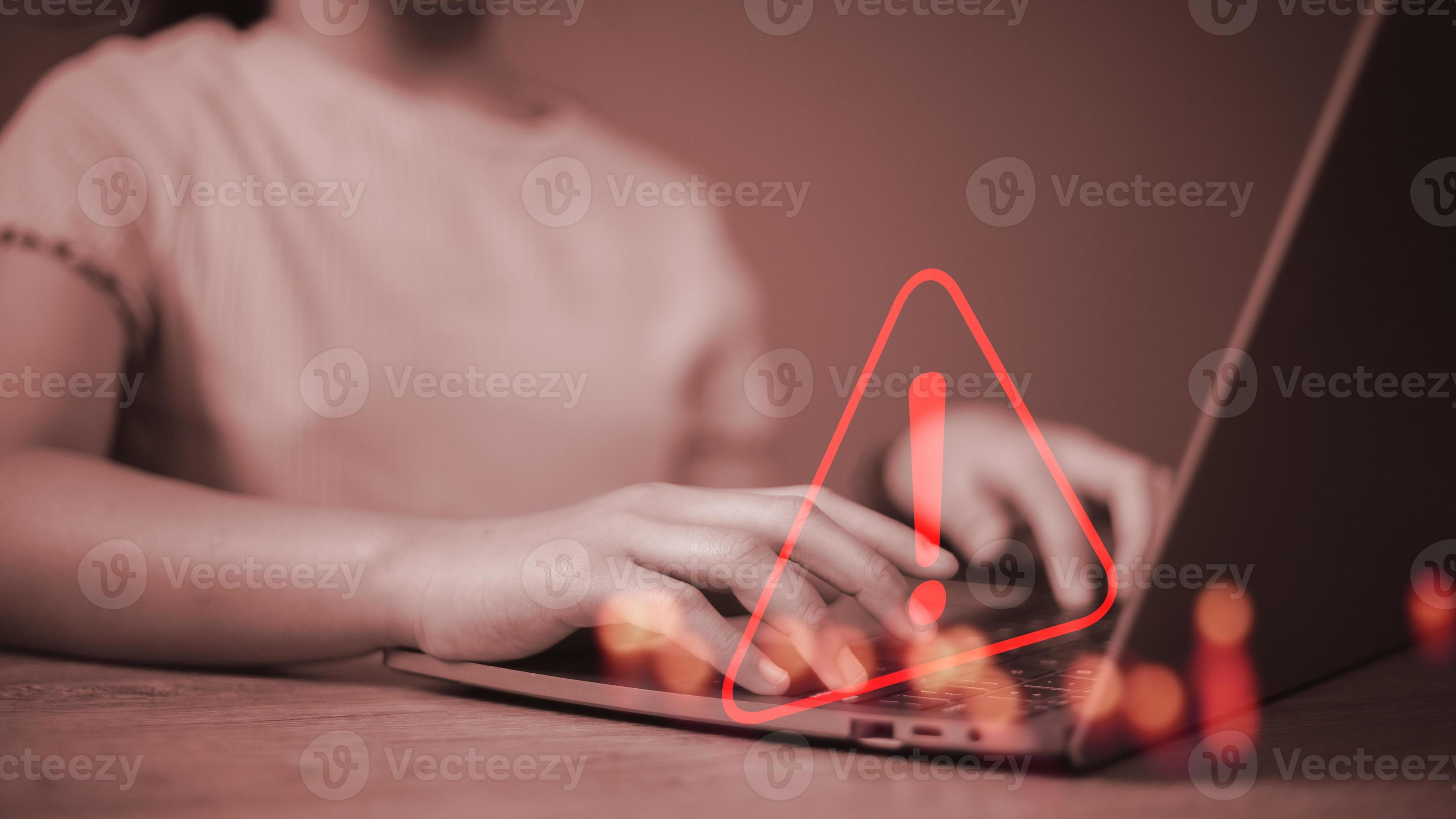 developer using computer laptop with triangle caution warning sign for ...