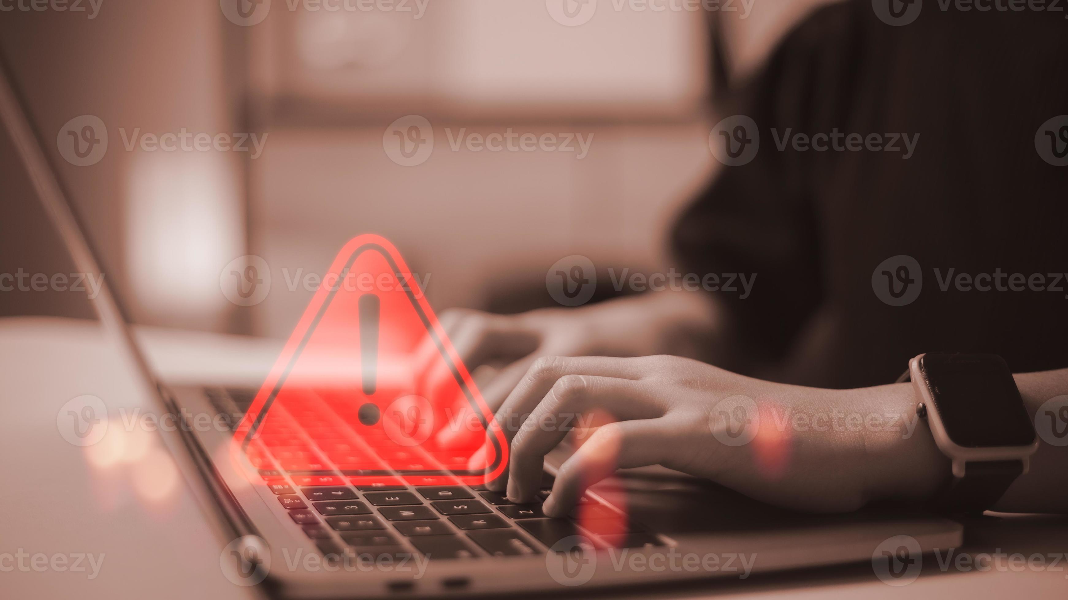 developer using computer laptop with triangle caution warning sign for notification error and ...