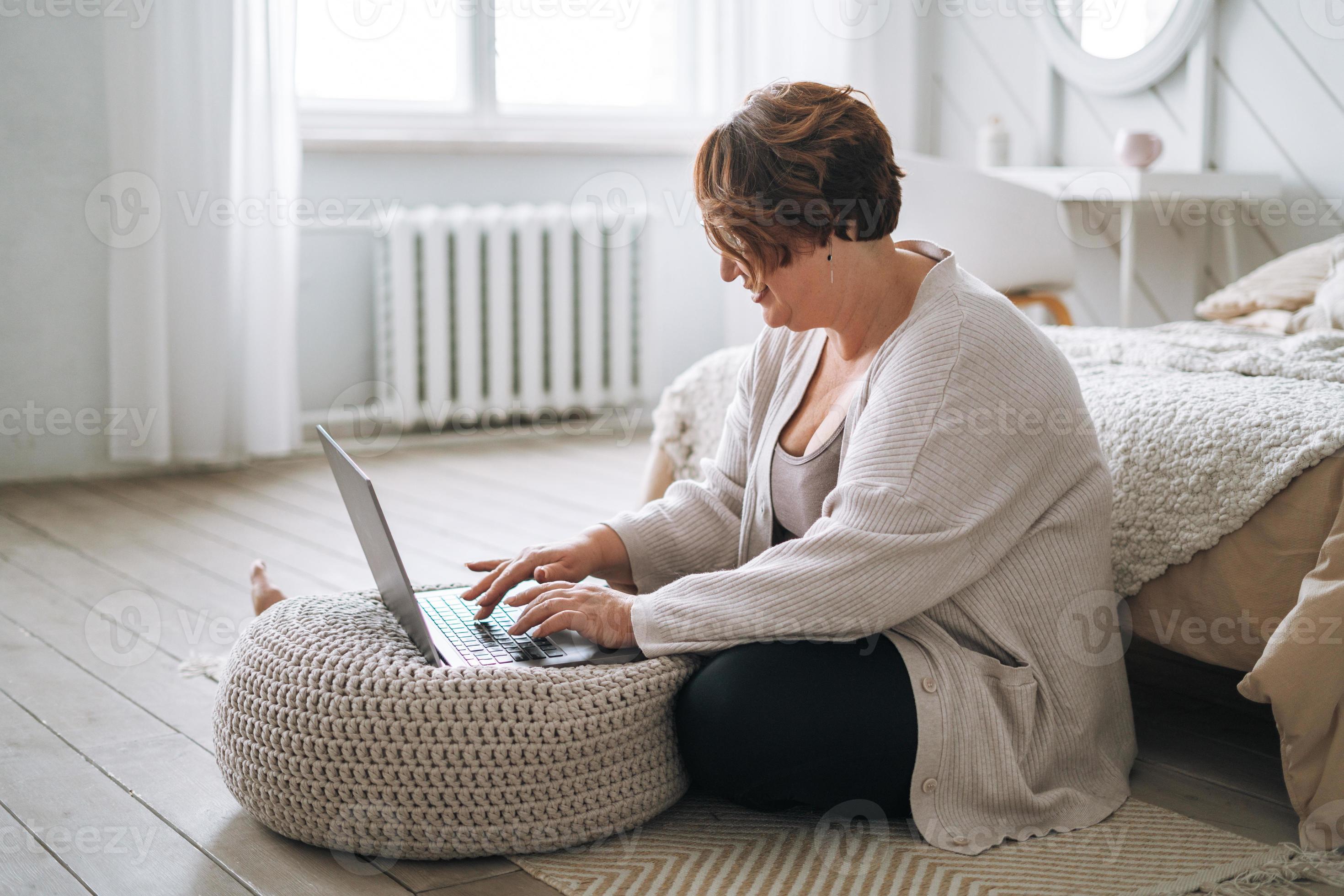 Smiling middle aged plus size woman working on laptop from home 21033305 Stock Photo at Vecteezy