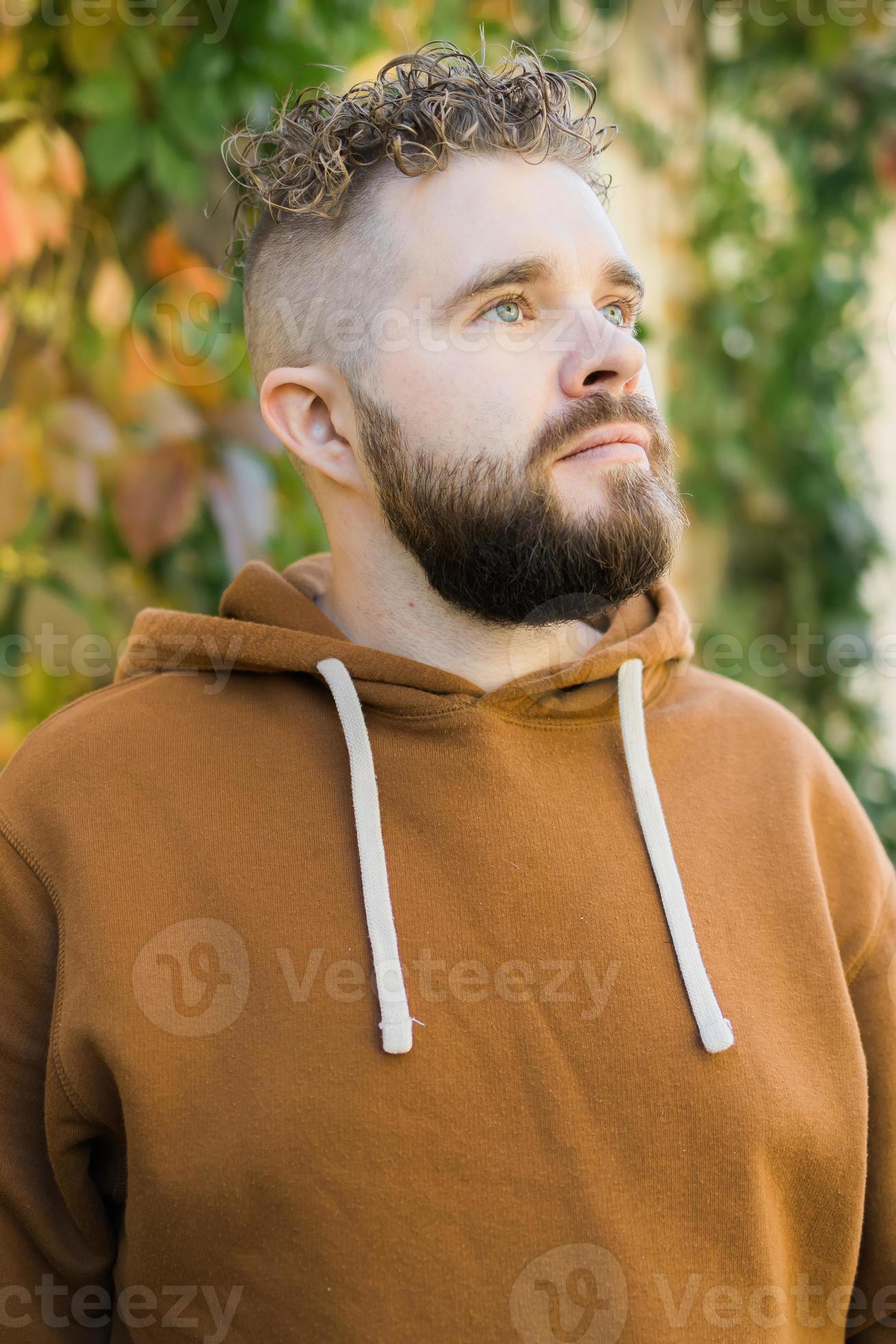 Outdoor portrait of young handsome smiling curly hair style man with ...