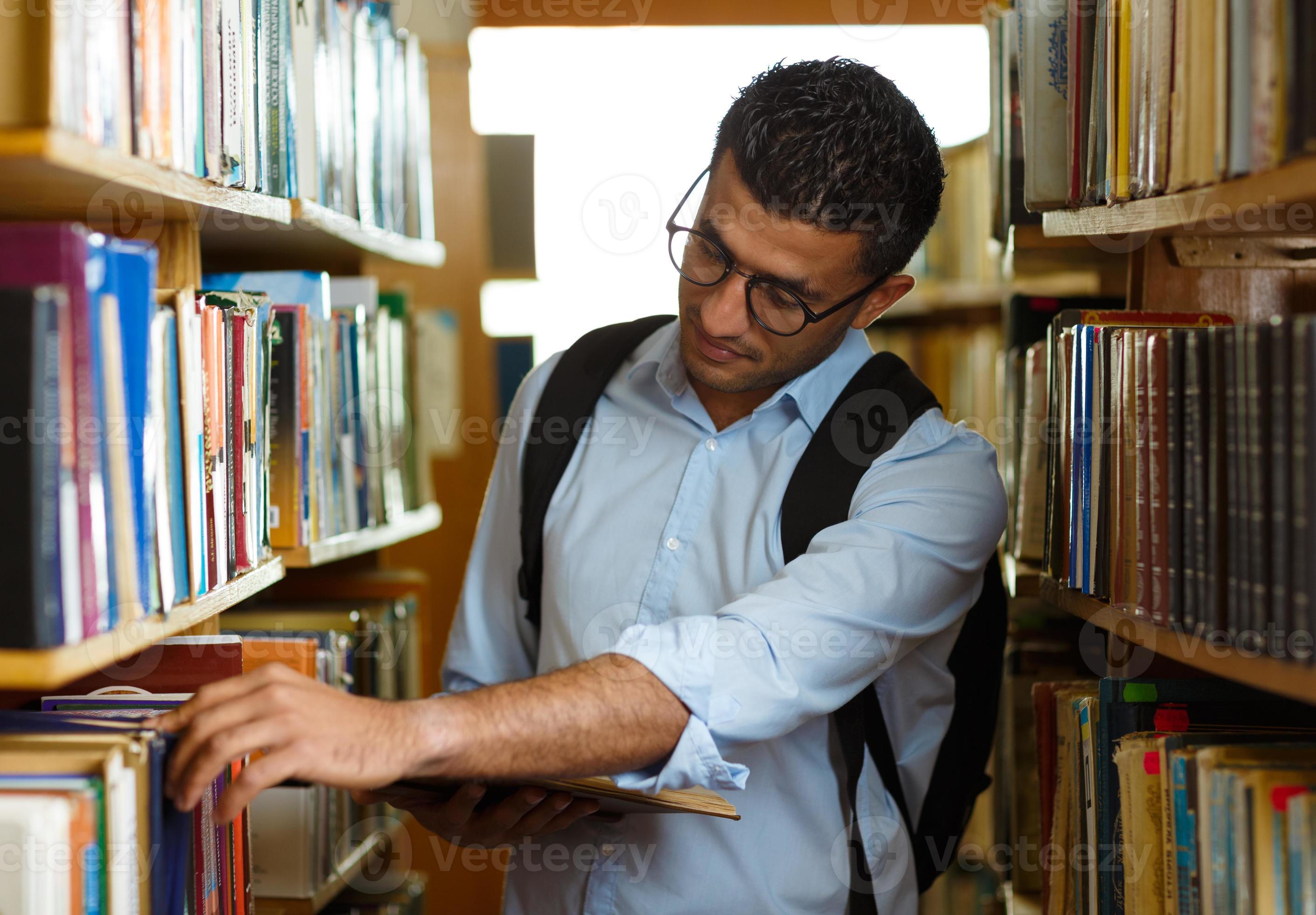 Young man in the library 21145422 Stock Photo at Vecteezy