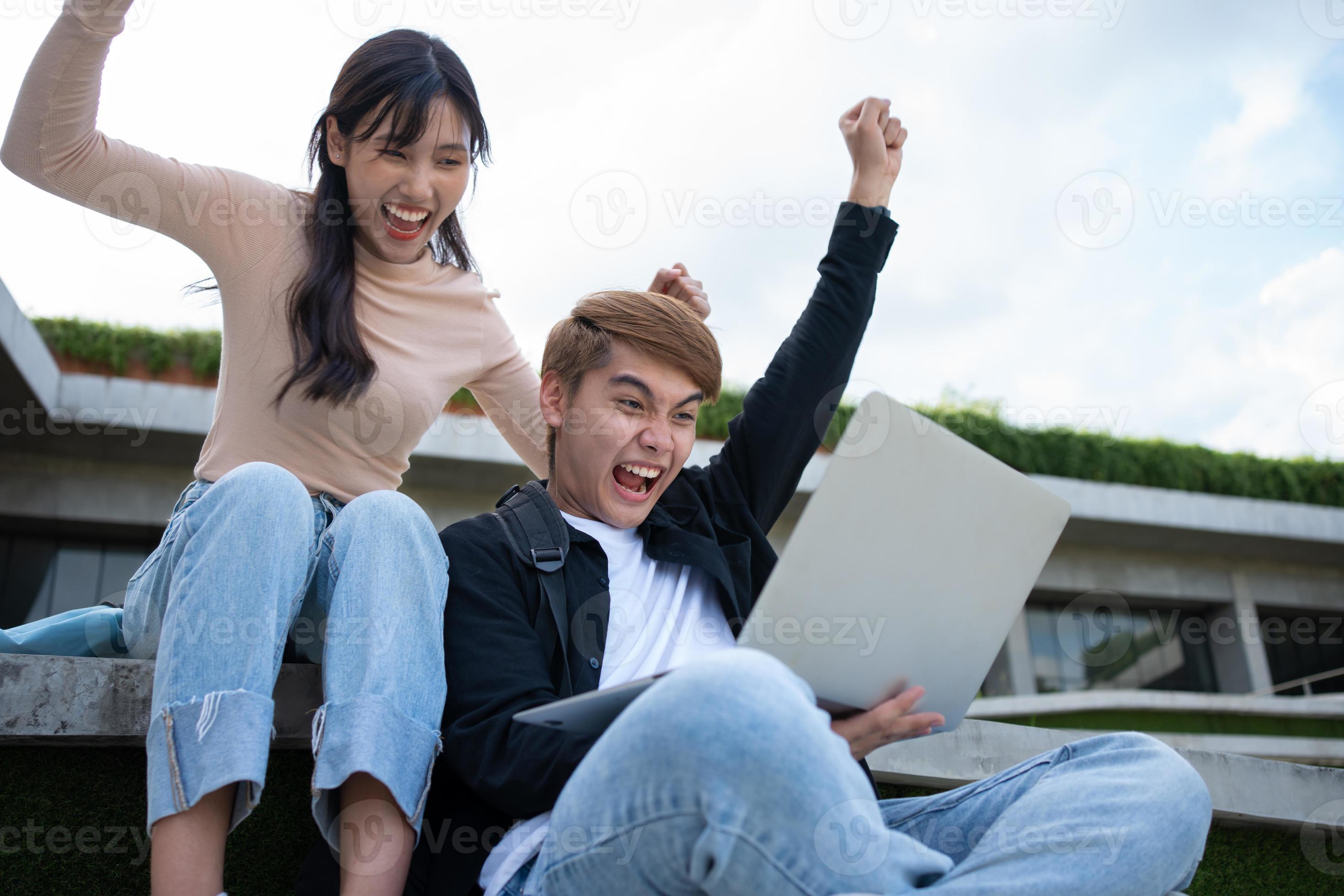 Asian students sitting on step are excited and happy after check exam ...