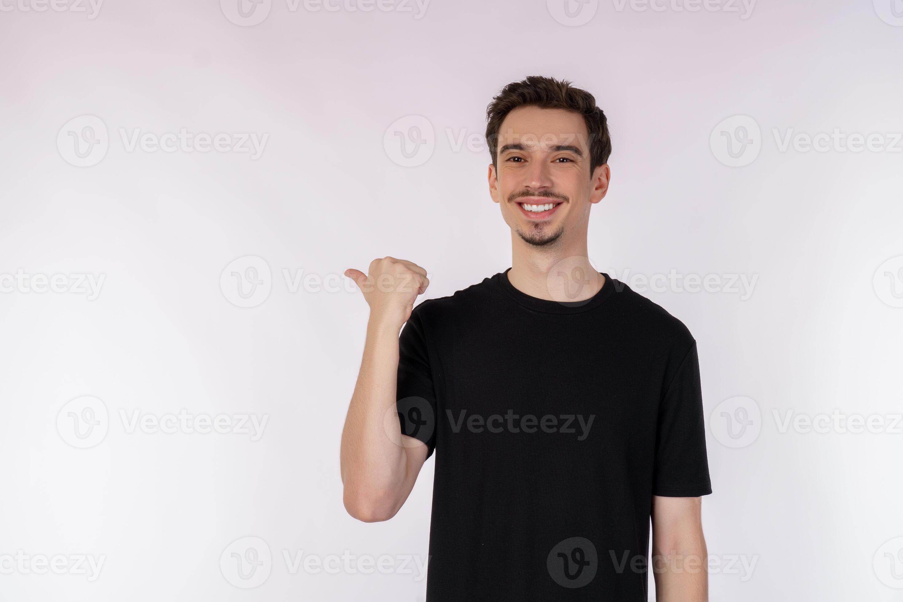 Portrait of young man pointing fingers at copy space isolated on white ...