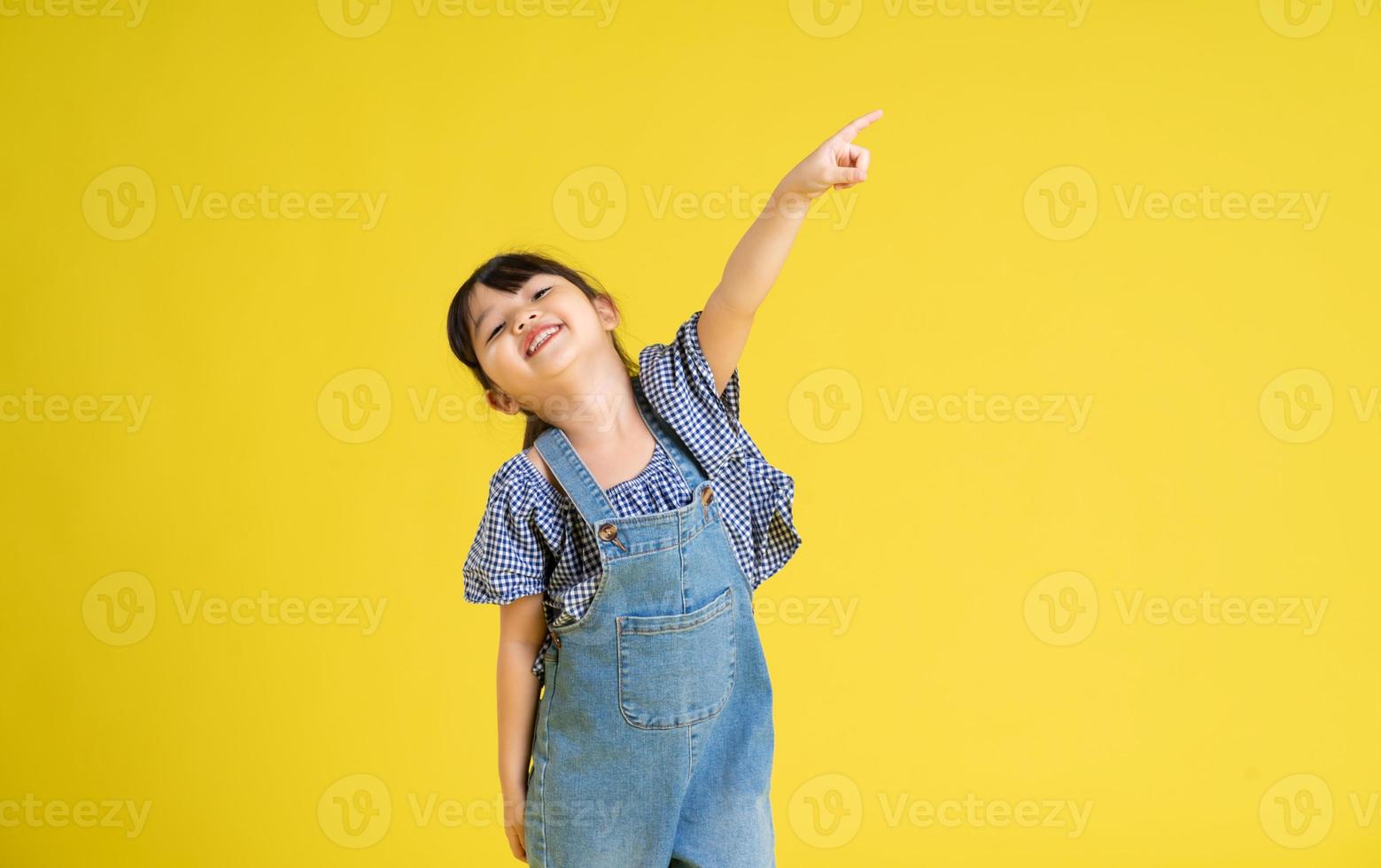 Portrait Of A Beautiful Asian Girl Isolated On Yellow Background