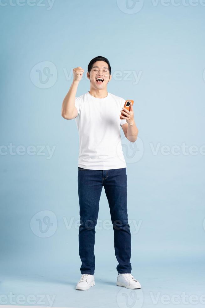 portrait of asian man posing on blue background 21512870 Stock Photo at ...