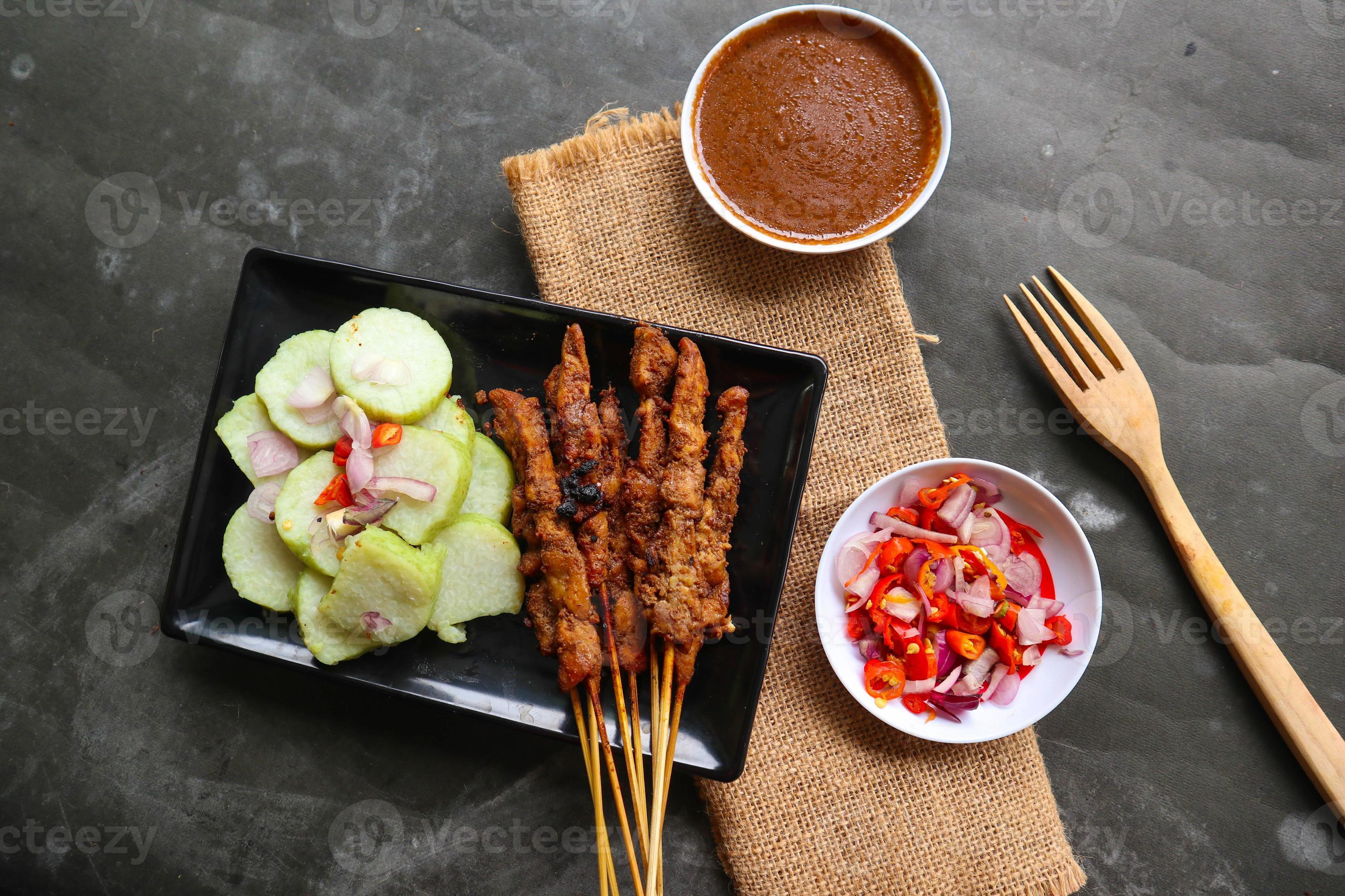chicken satay or sate ayam served with lontong, rice cake and peanut sauce. 21525668 Stock Photo ...