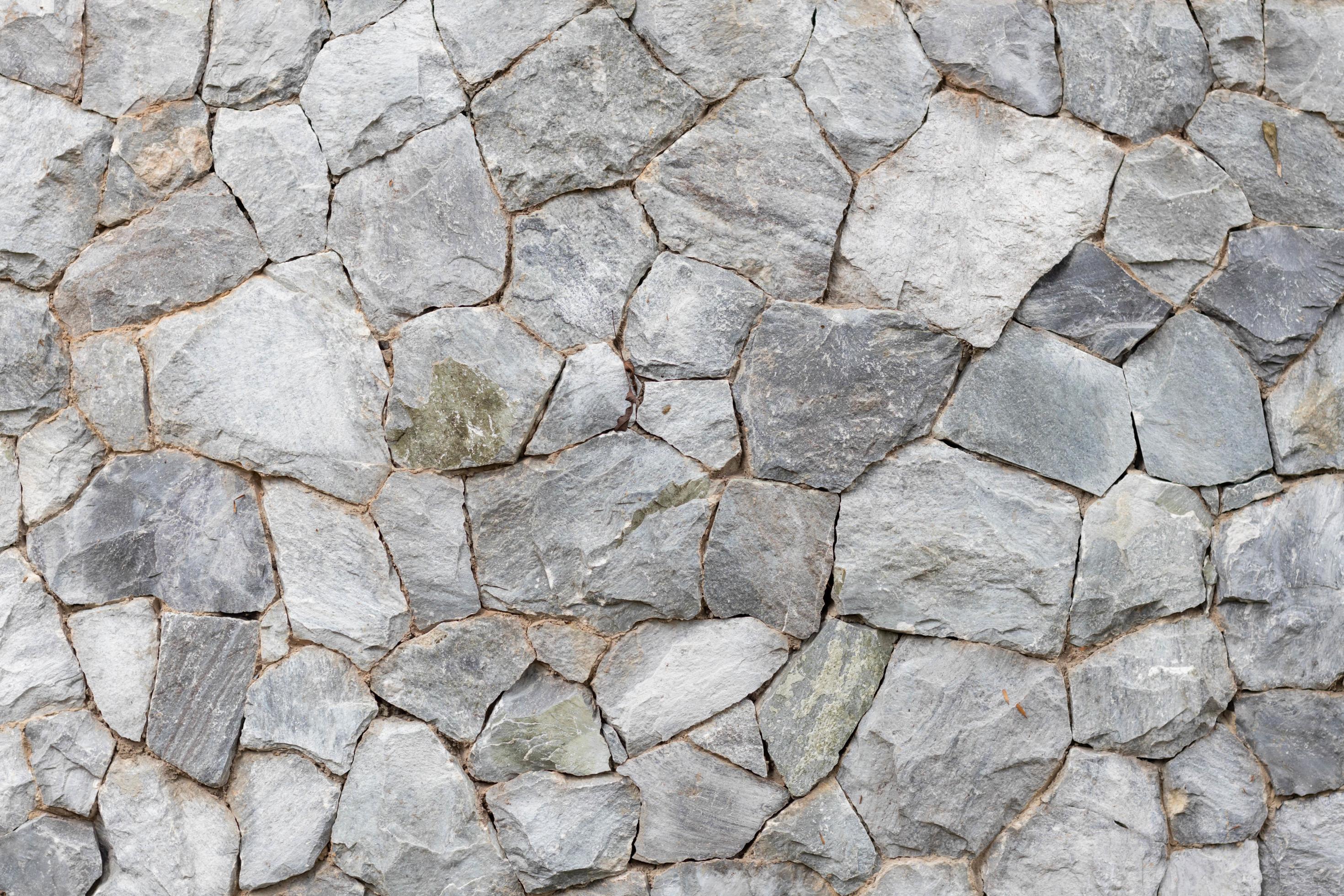 The stone wall background that was constructed from natural stones and arranged to be beautiful ...