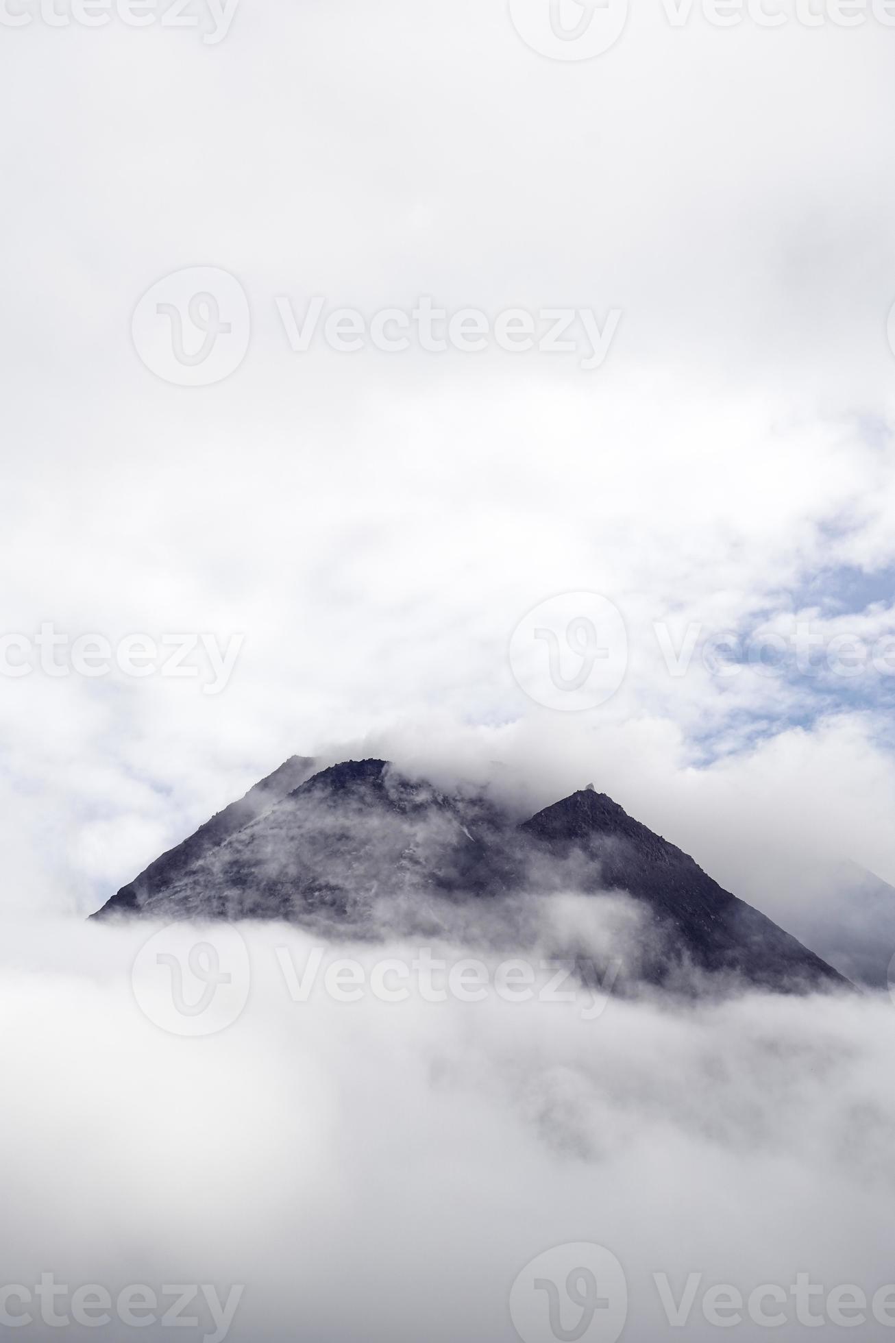The dramatic view of Mount Merapi covered in clouds is very dense ...