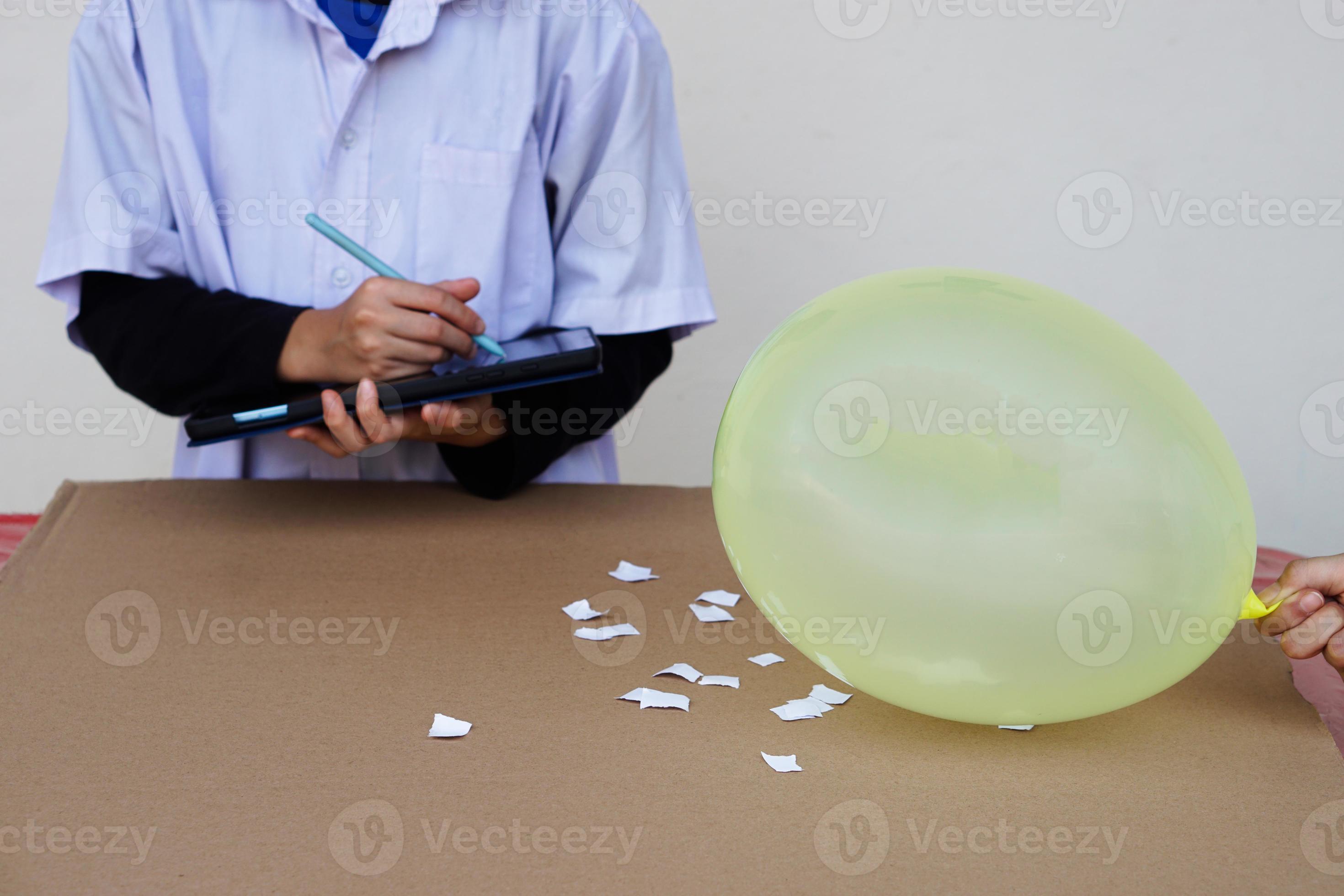 Closeup student doing science experiment about static electricity ...