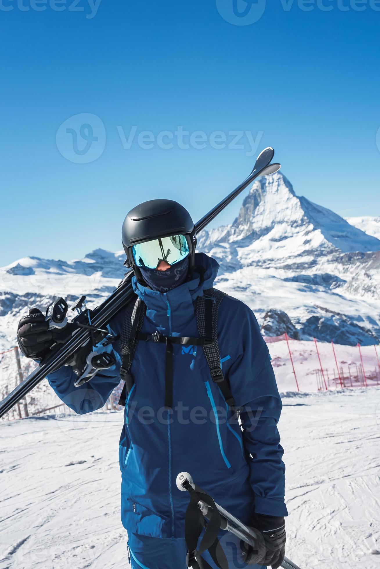 Young skier enjoying Zermatt ski resort. Beautiful sunny day with a ...