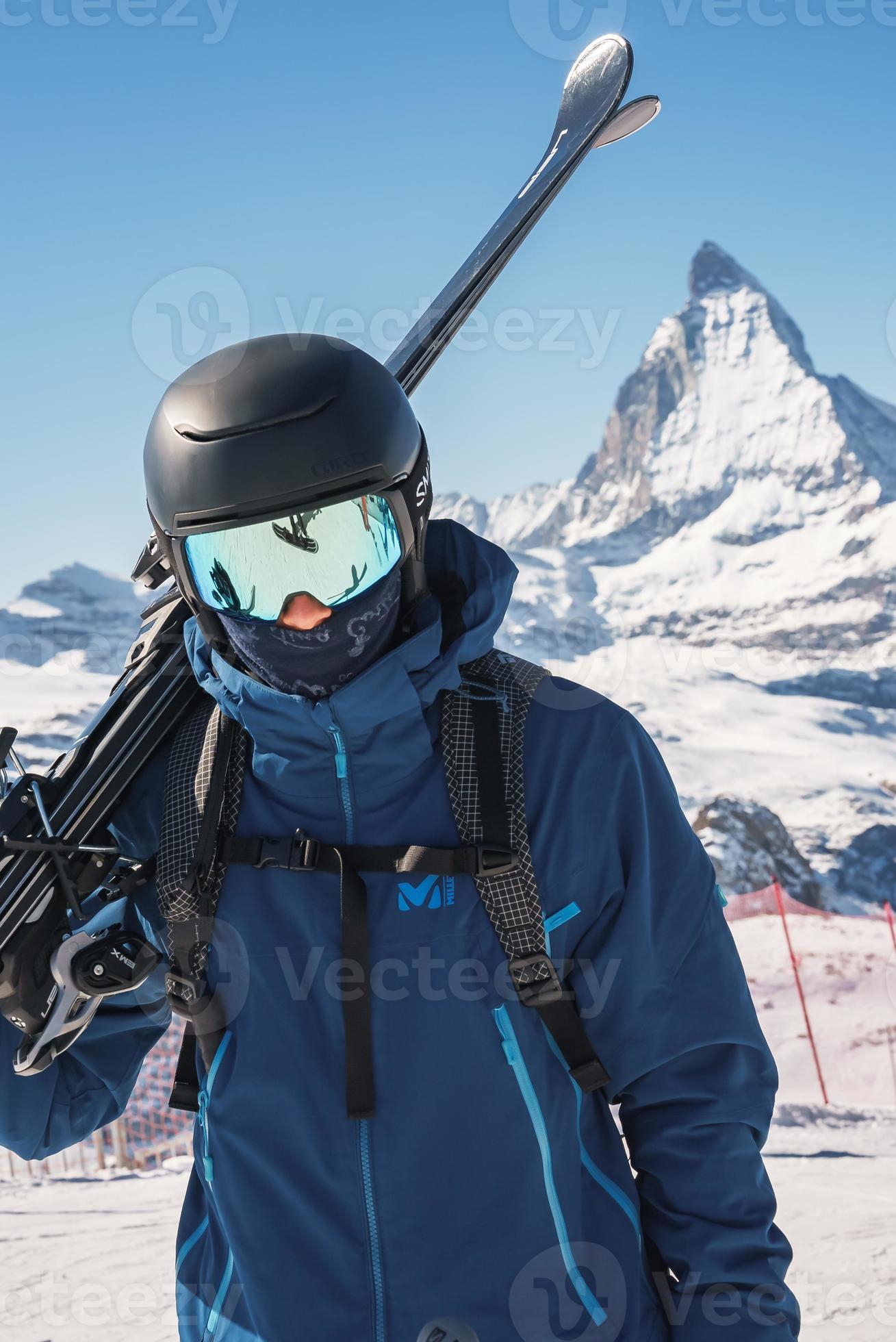 Young skier enjoying Zermatt ski resort. Beautiful sunny day with a ...