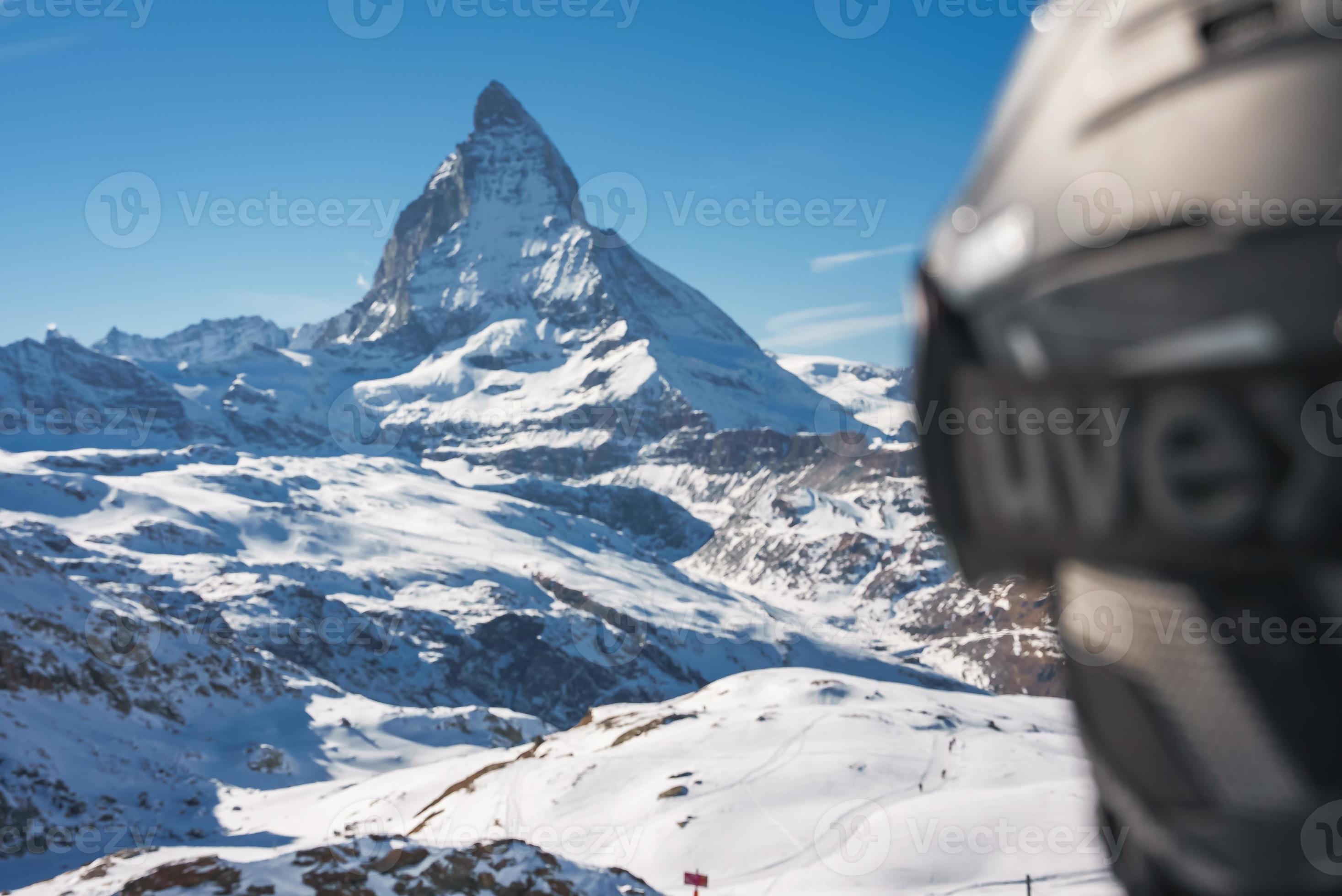 Young skier enjoying Zermatt ski resort. Beautiful sunny day with a ...