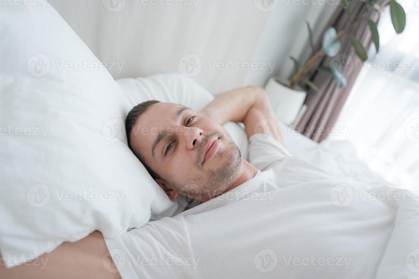 A young man wakes up in a comfortable. 21808887 Stock Photo at Vecteezy