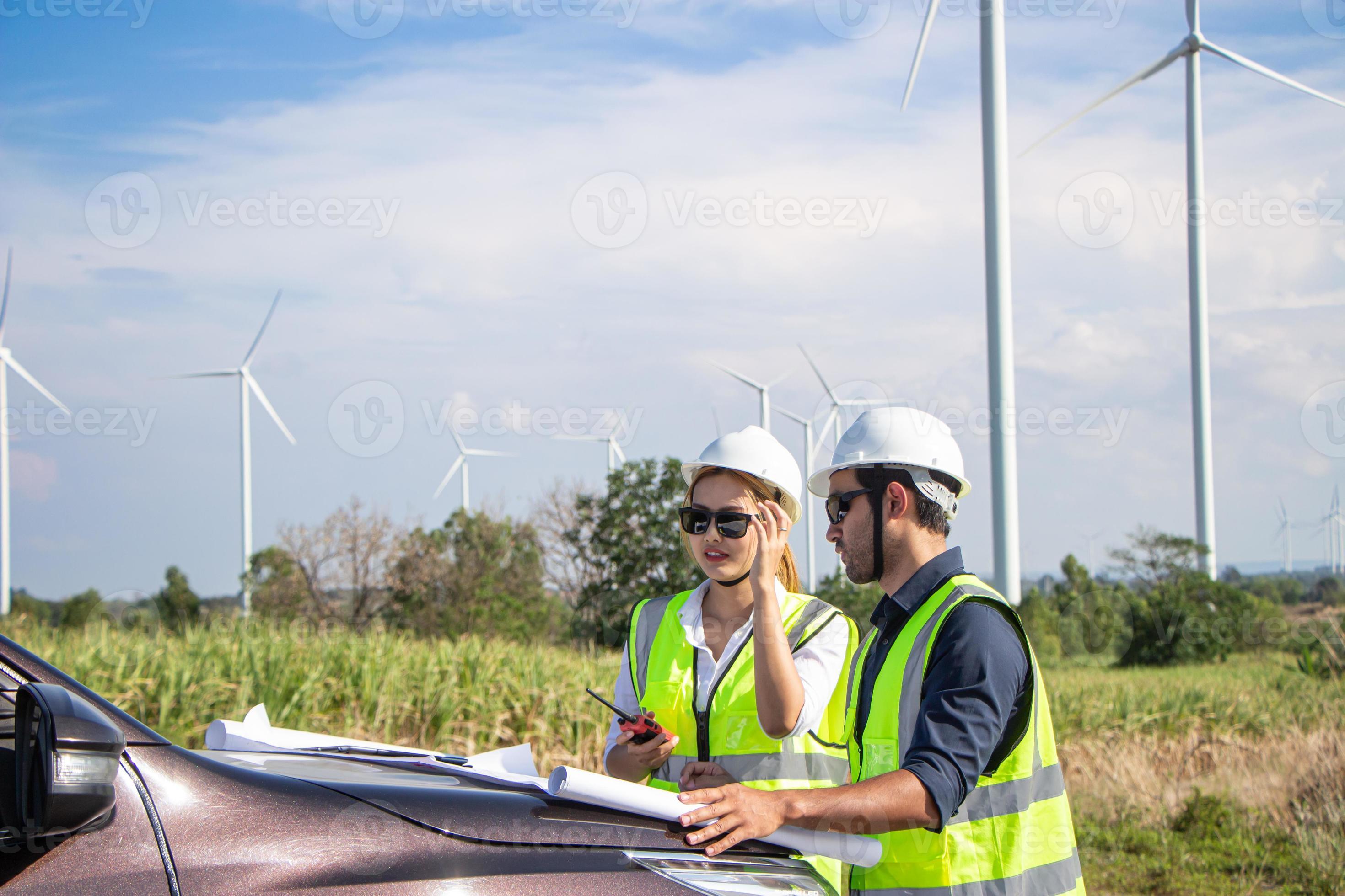 engineer team working in wind turbine farm. Renewable energy with wind generator by alternative ...