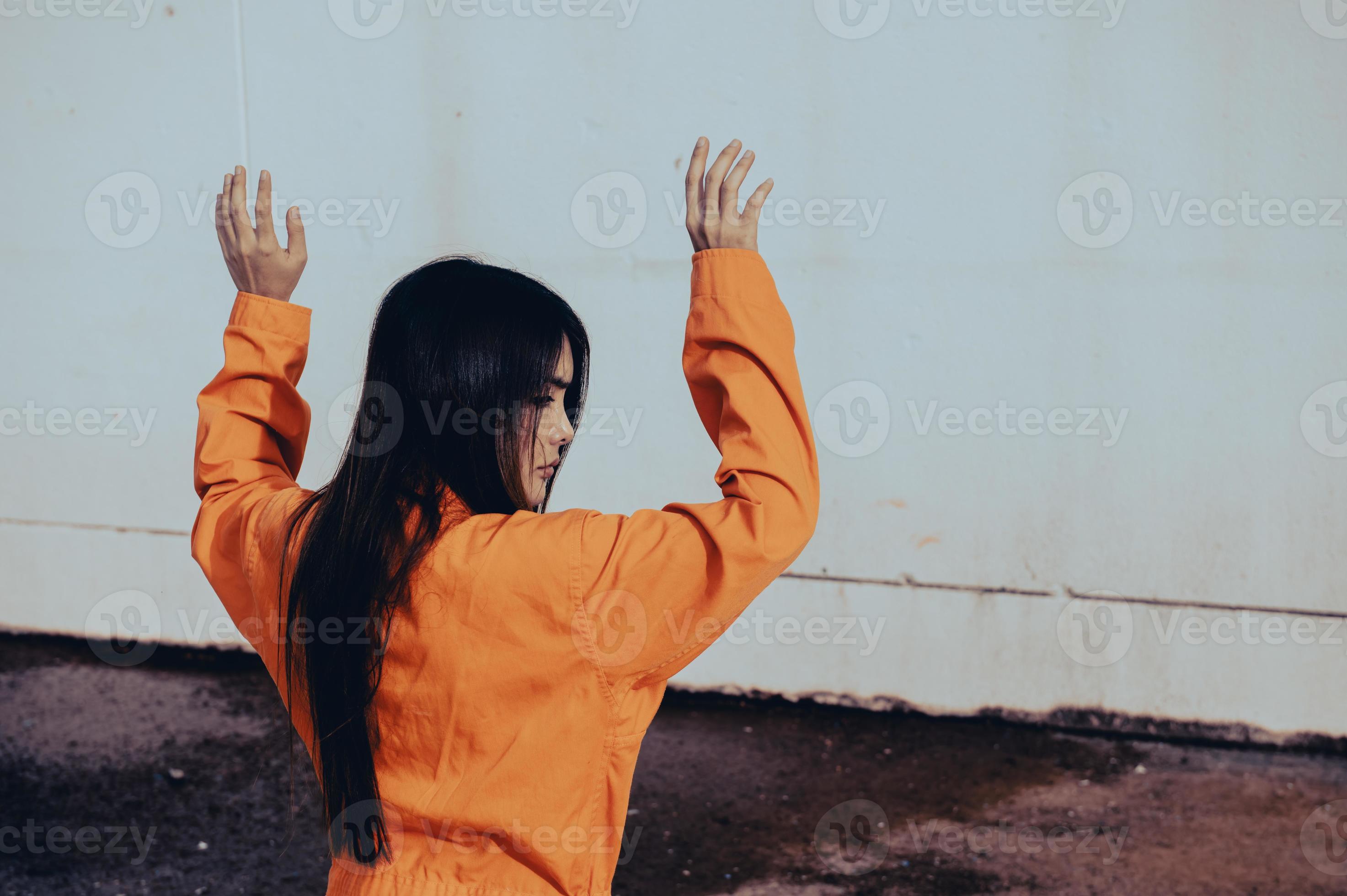 Prisoner In Orange Robe Conceptportrait Of Asian Woman In Prison Uniforms On White Background