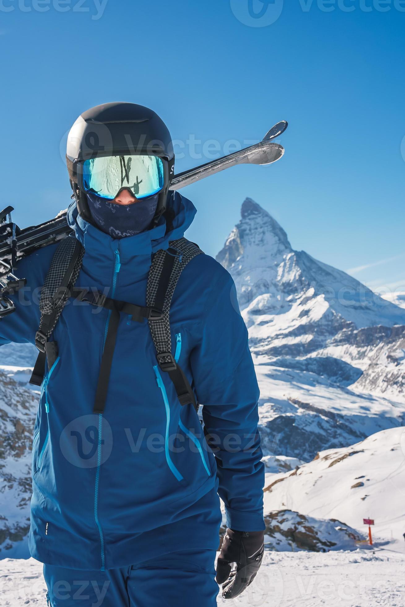 Young skier enjoying Zermatt ski resort. Beautiful sunny day with a ...