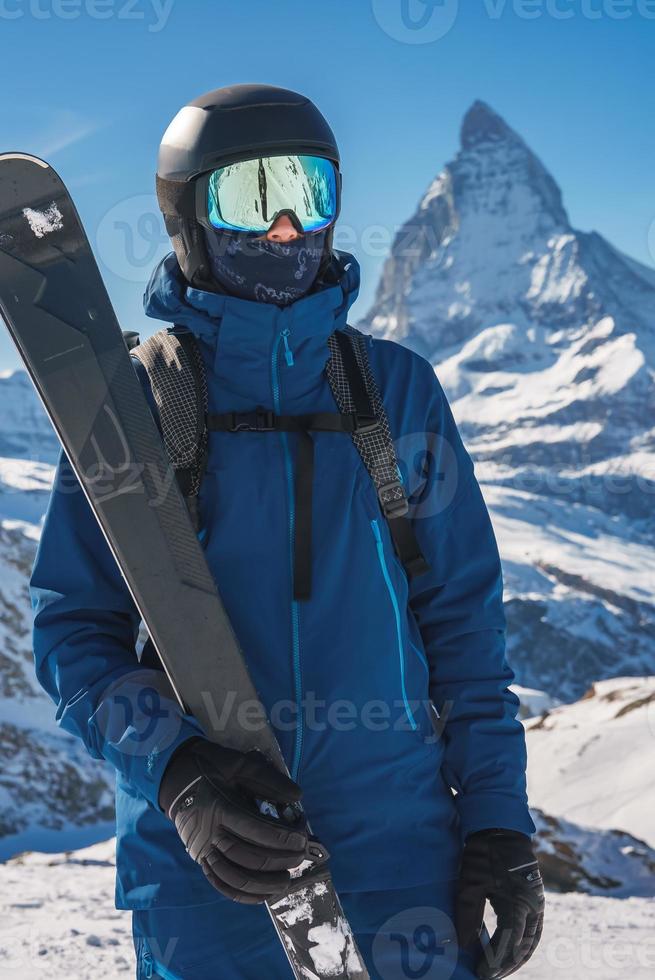 Young skier enjoying Zermatt ski resort. Beautiful sunny day with a ...