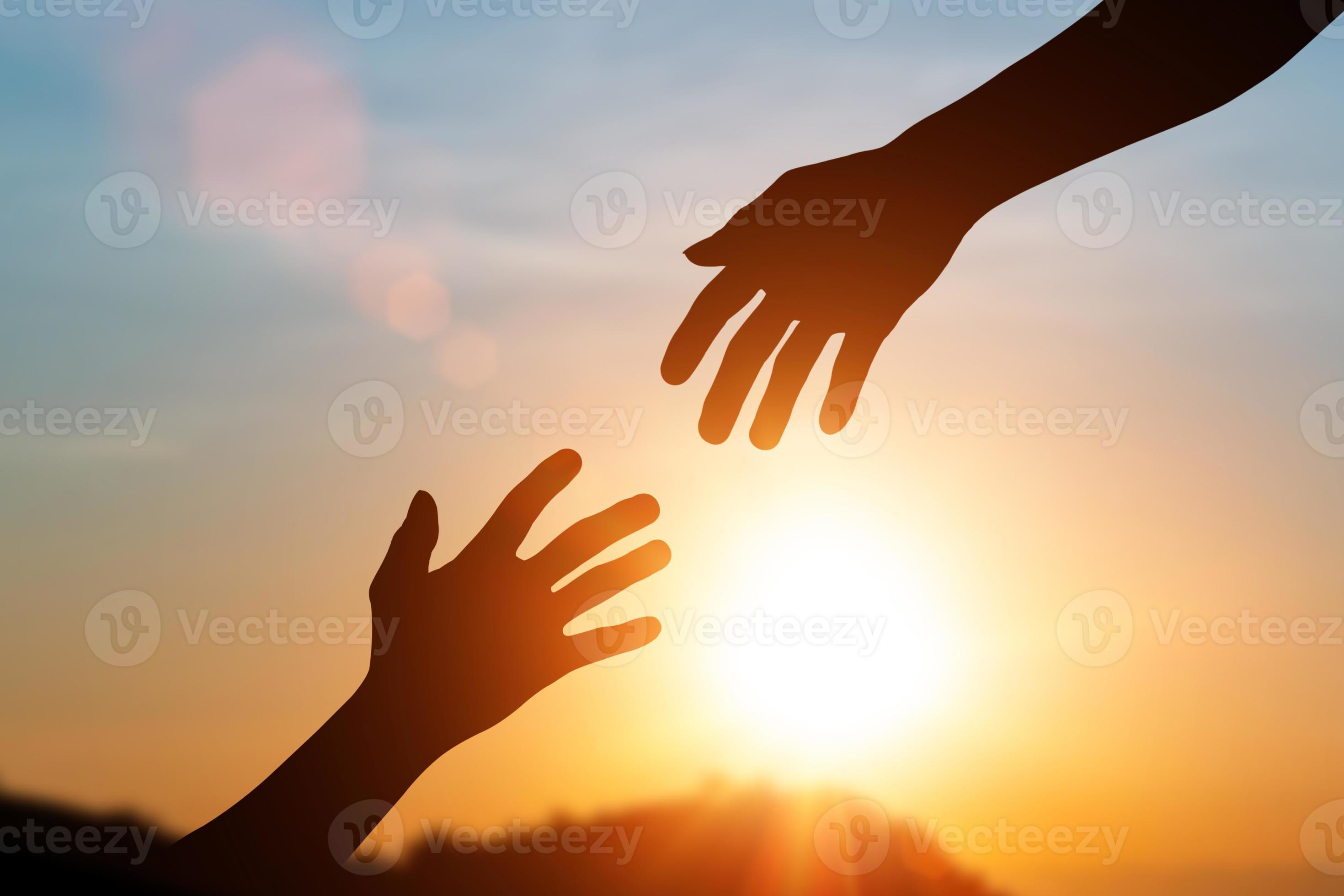 Silhouette of helping hand and develop a friendship. international day of peace concept. helping ...