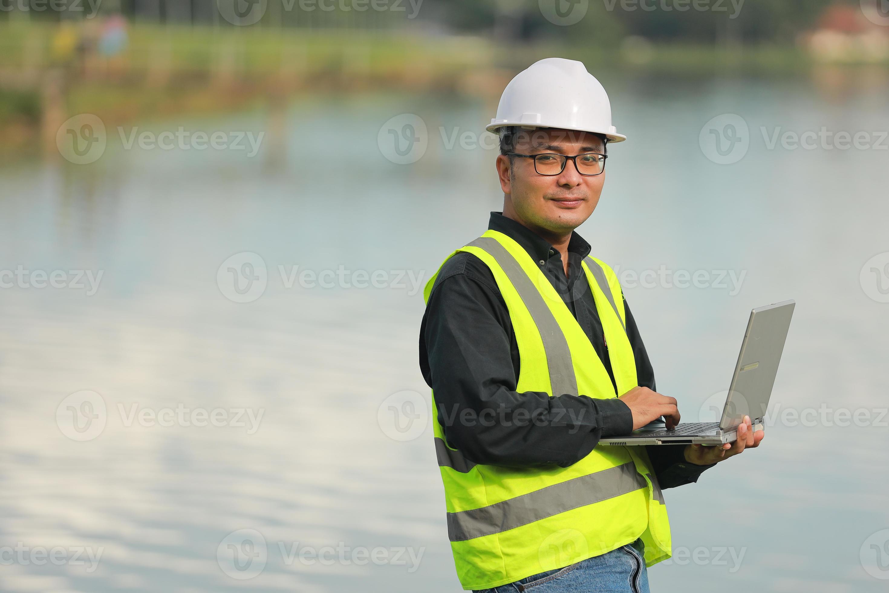 Environmental engineers work at water source to check for contaminants ...