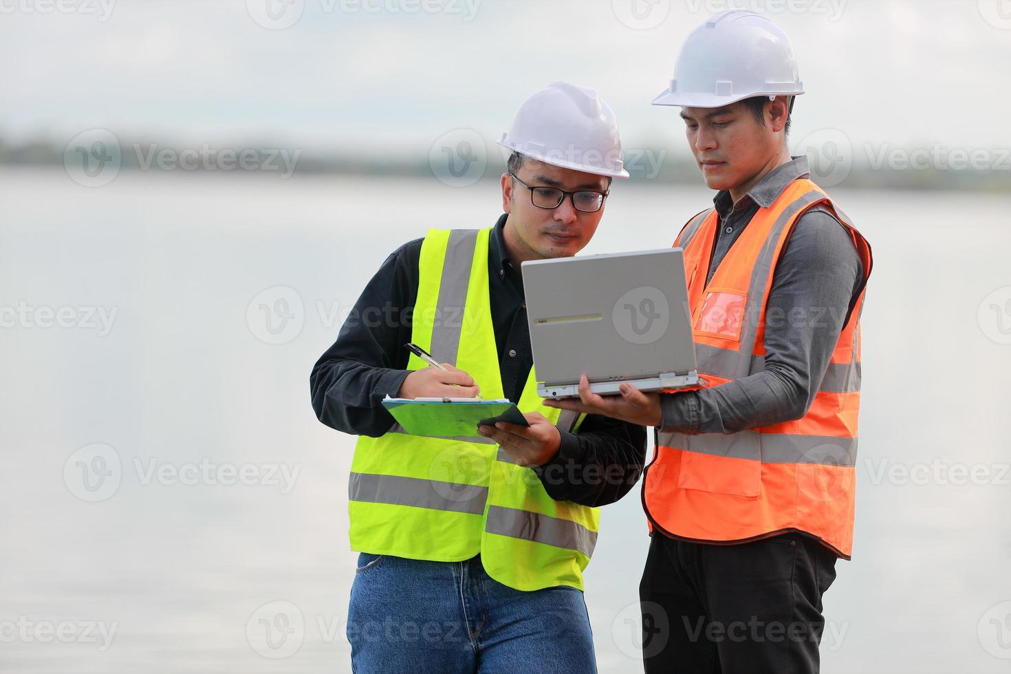 Environmental engineers work at water source to check for contaminants in water sources and ...