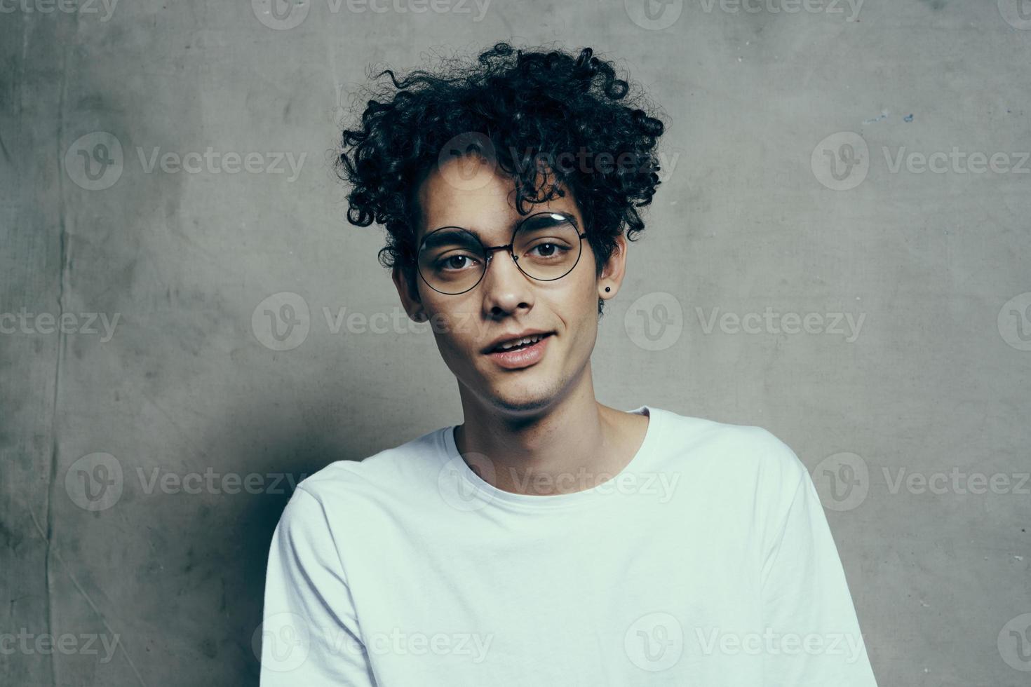 man with curly hair wearing glasses emotions white t-shirt studio ...