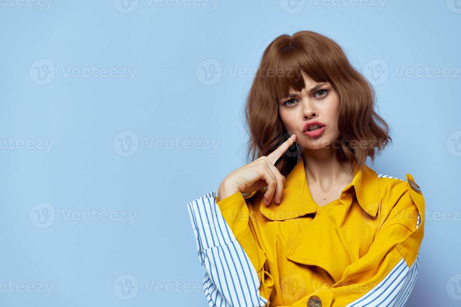 Beautiful Woman Holding Her Finger Near Her Lips Yellow Coat Striped