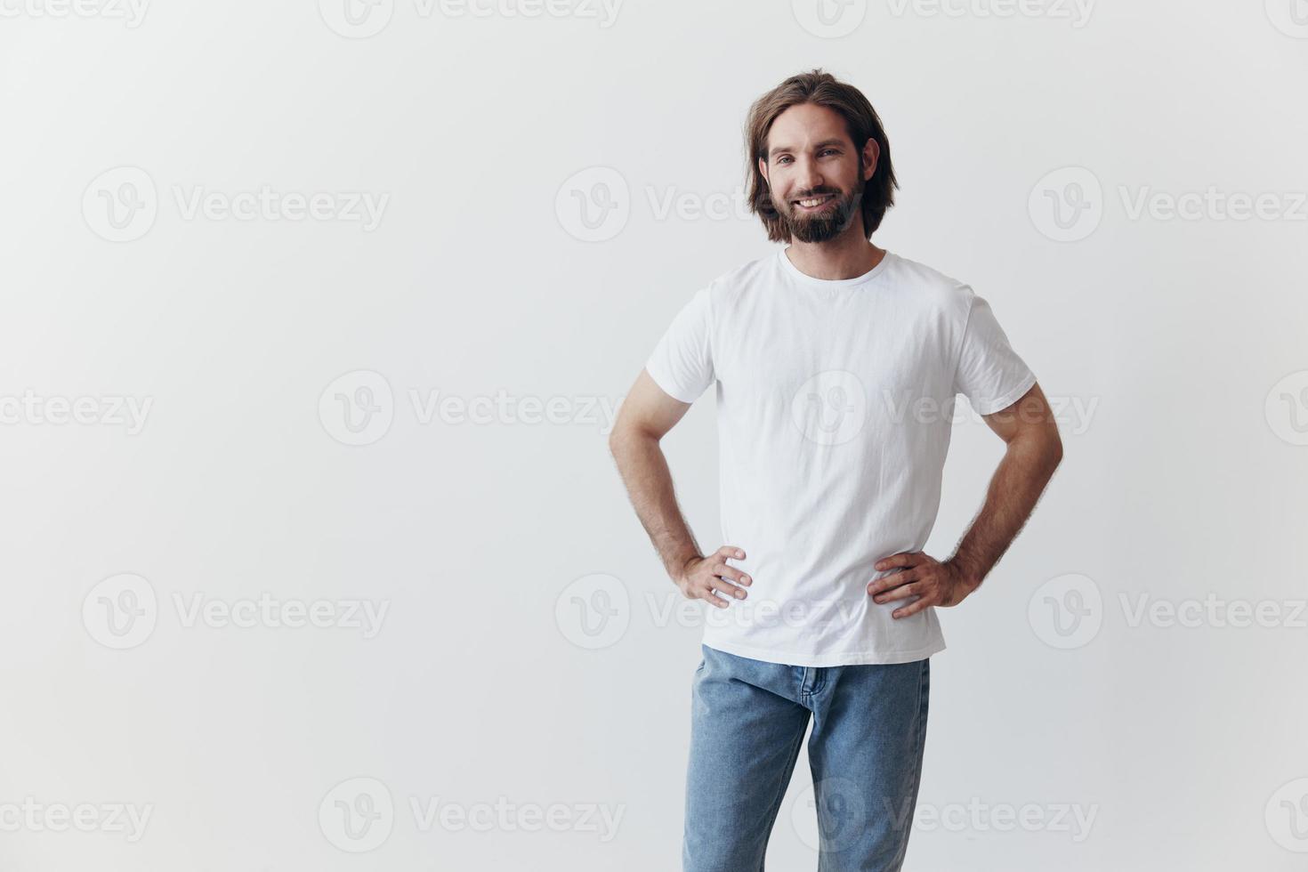 Portrait of a man with a black thick beard and long hair in a white T ...