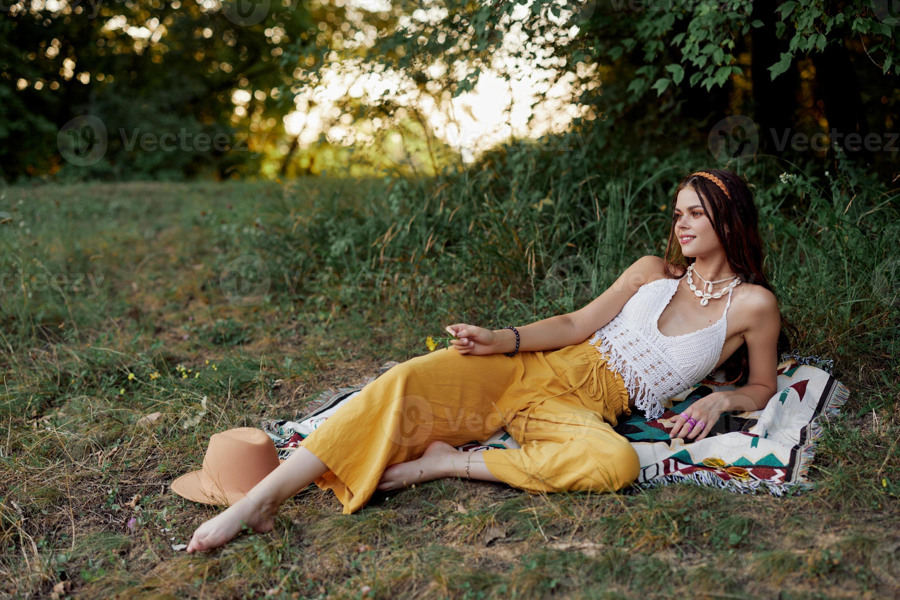 Young Beautiful Hippie Woman Lying On The Ground In Nature In The Fall