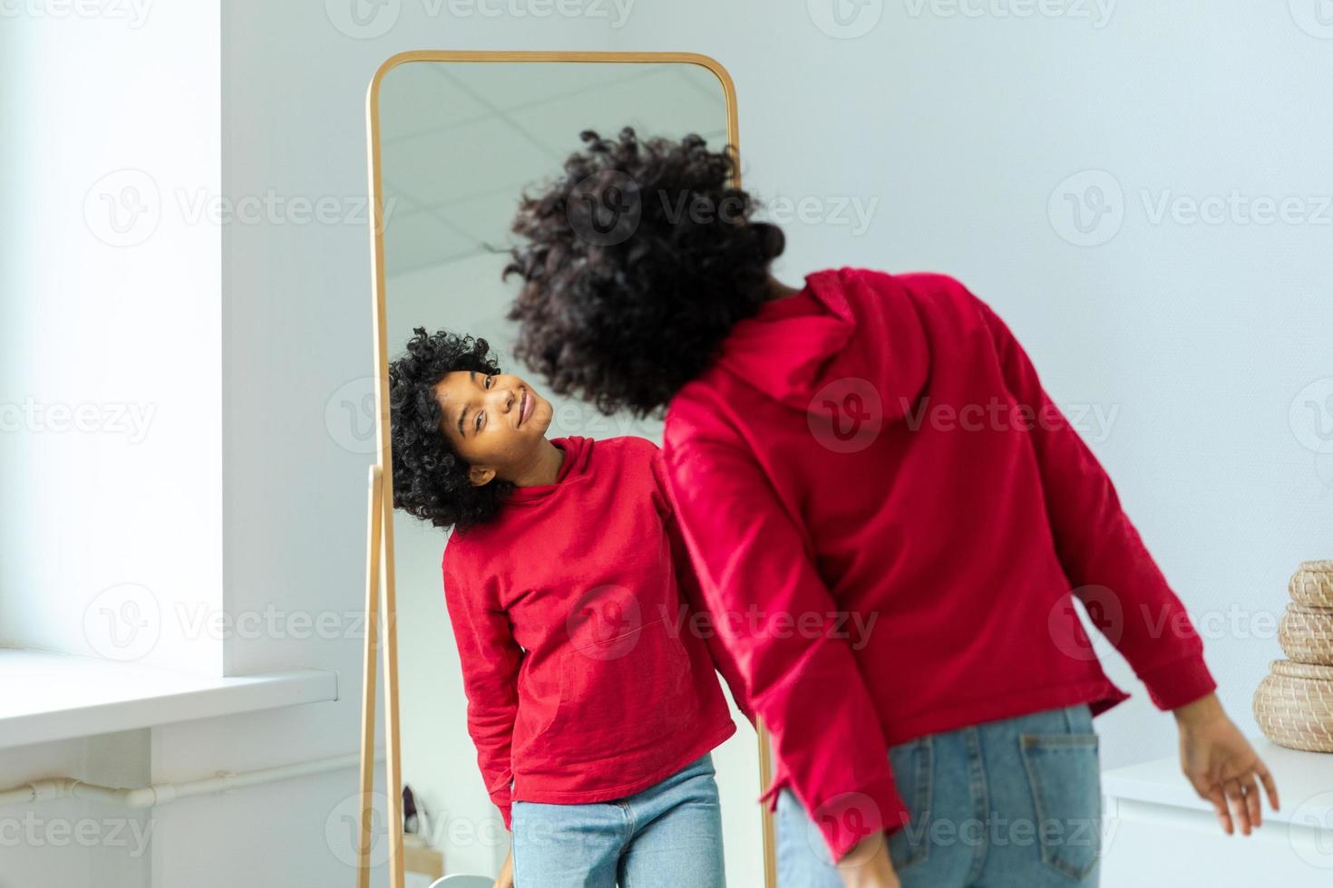 Love yourself. Beautiful young smiling african american woman dancing enjoying her mirror ...