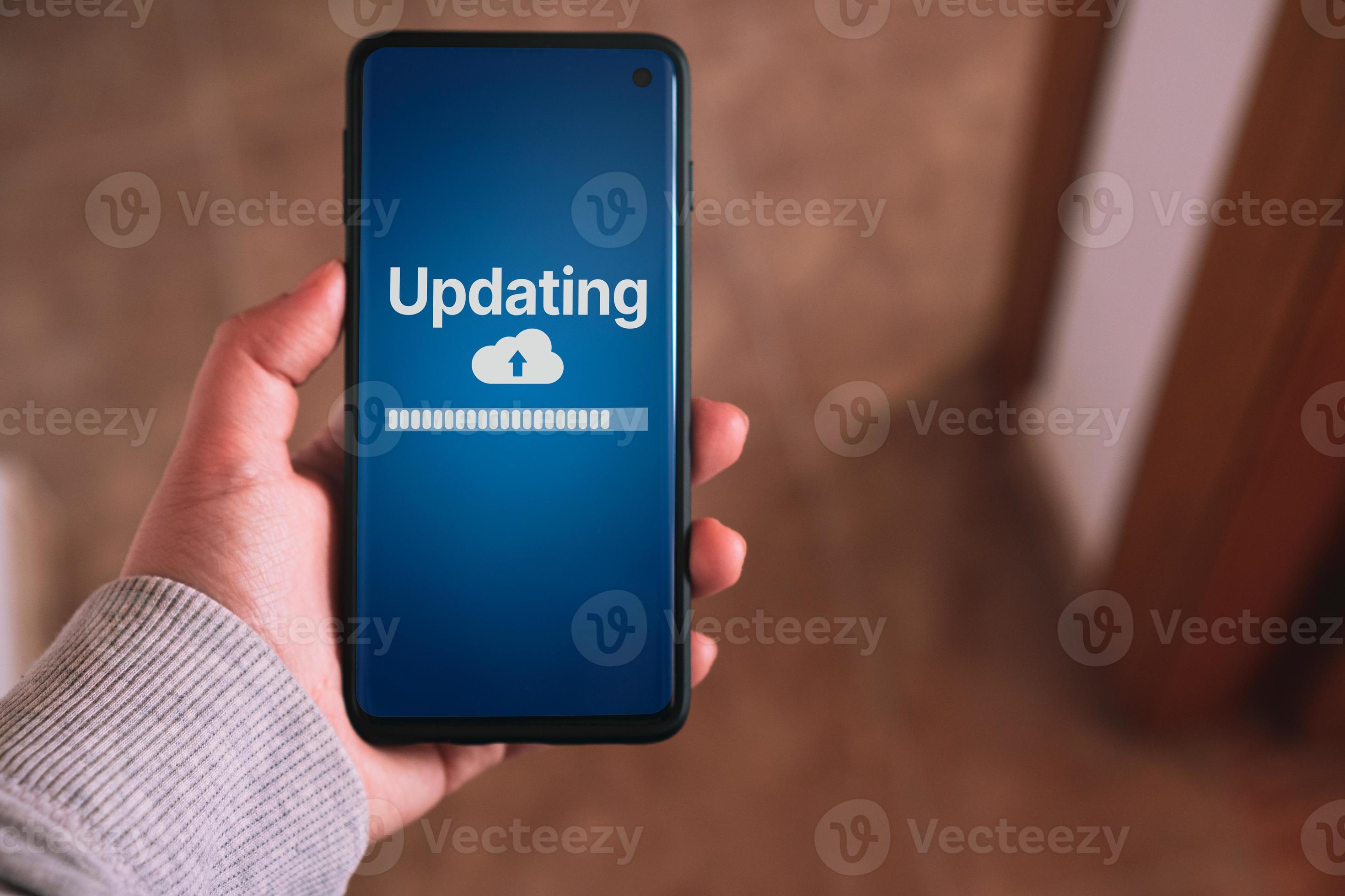 Woman updating software on smartphone. System engineer and programming ...