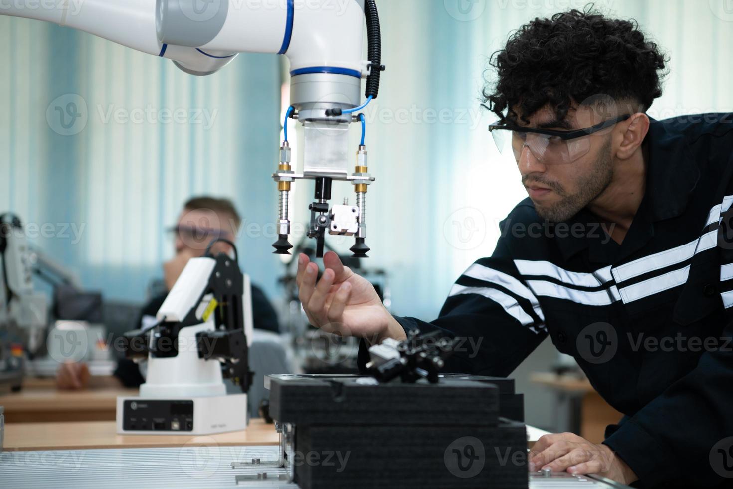 Students studying robotic hand technology are learning how to construct robotic hands for a ...