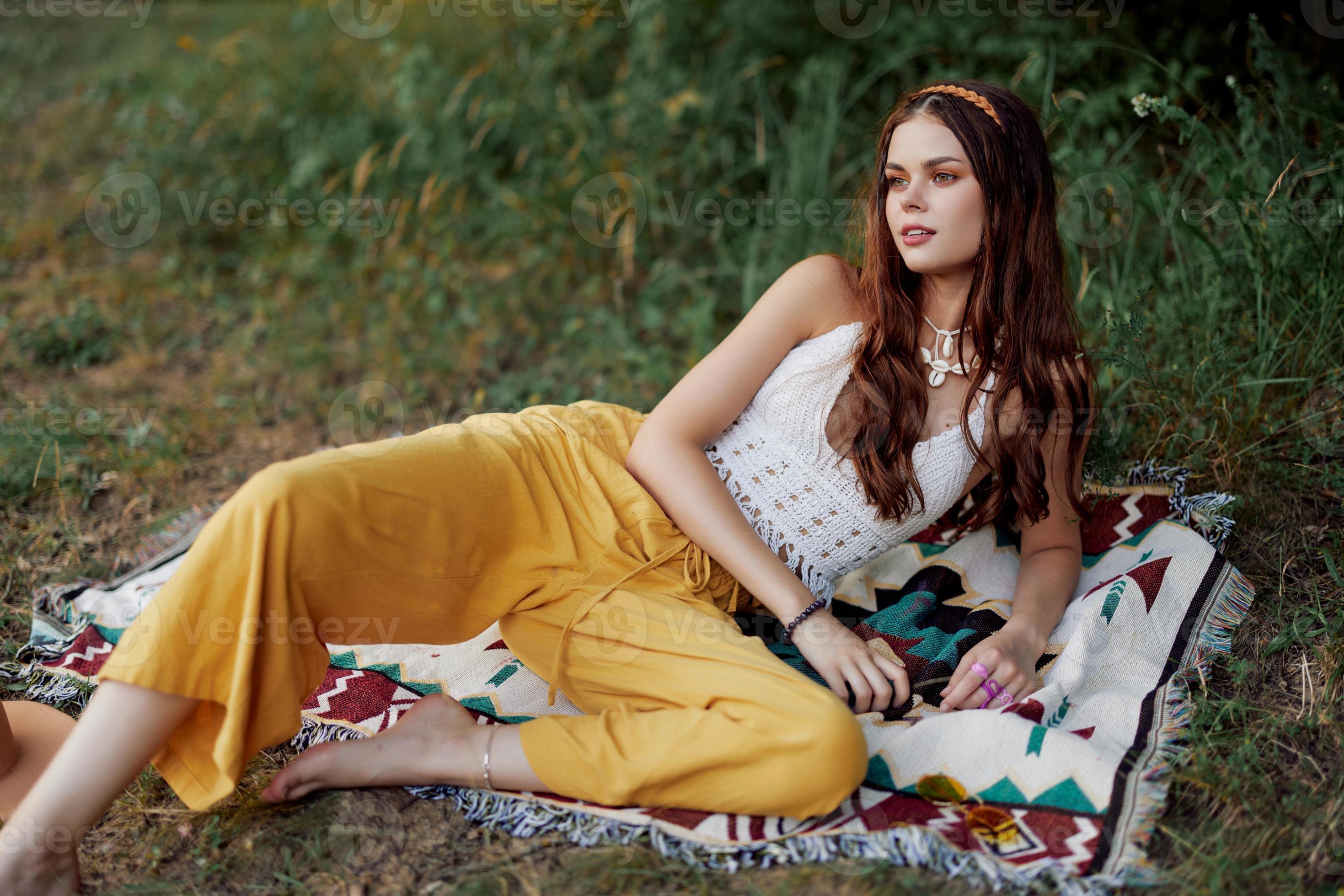 Young Beautiful Hippie Woman Lying On The Ground In Nature In The Fall