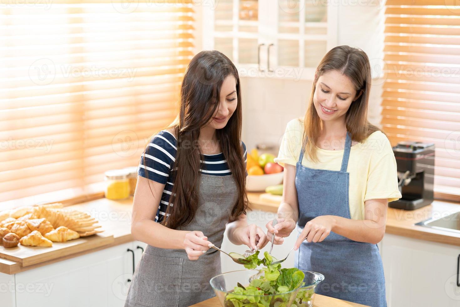 Happy And Smile Lesbian Couple Cooking Salad In The Kitchen Salad In