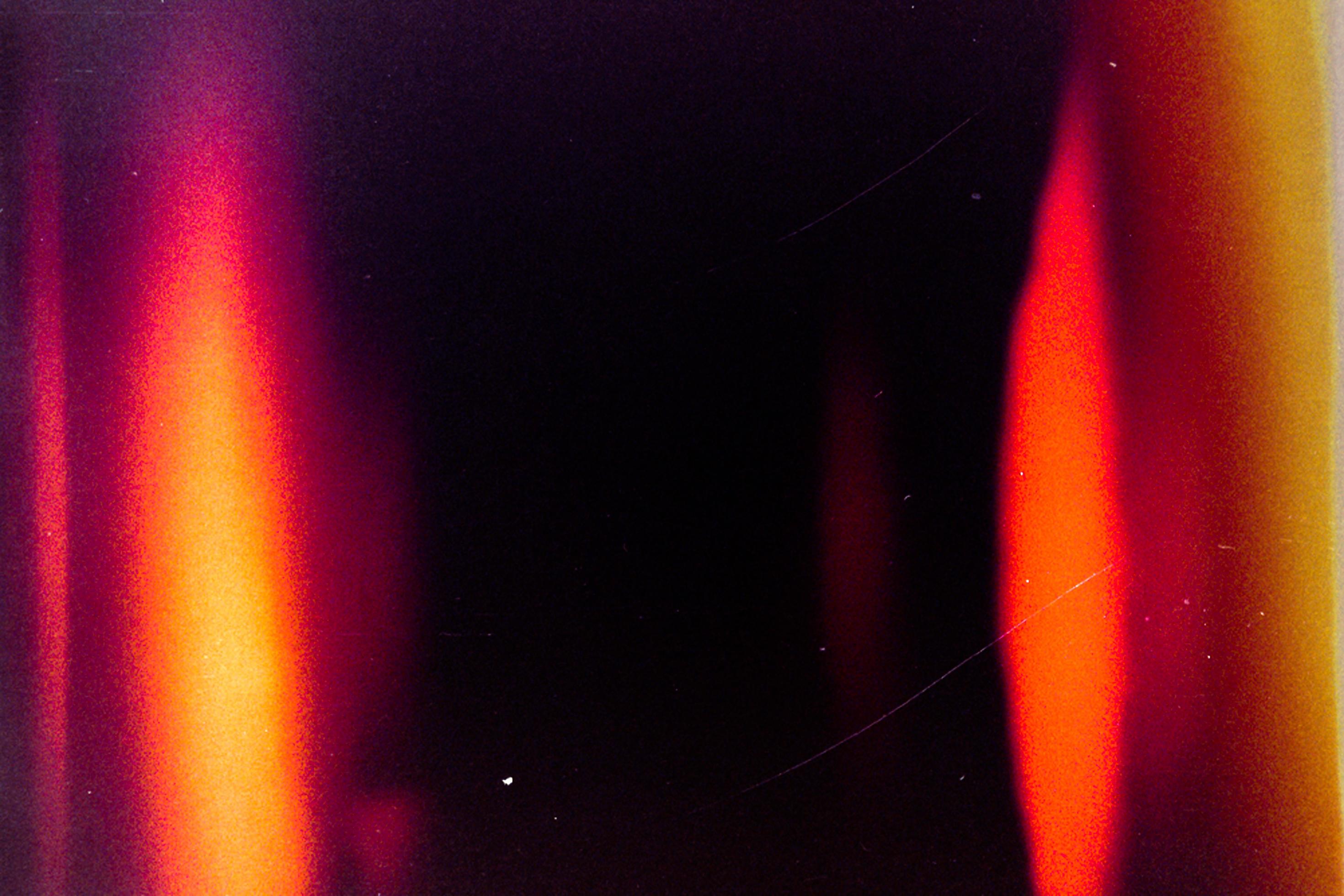 Blank grained and scratched film strip texture background with heavy grain, dust and a light ...